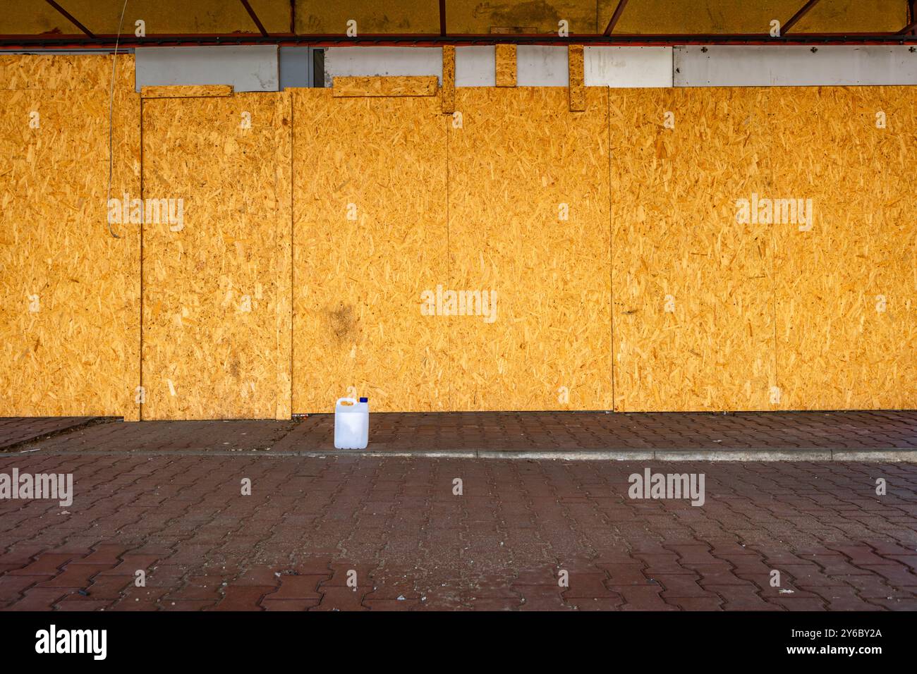 Inactive and abandoned gas station, inactive dispensers, boarded up ...