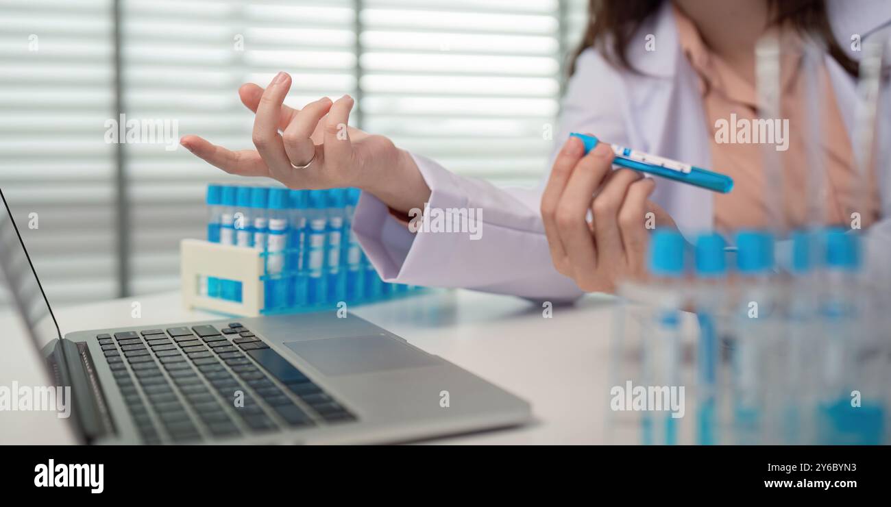Focused Scientist Presenting Research Findings Using Test Tubes and ...