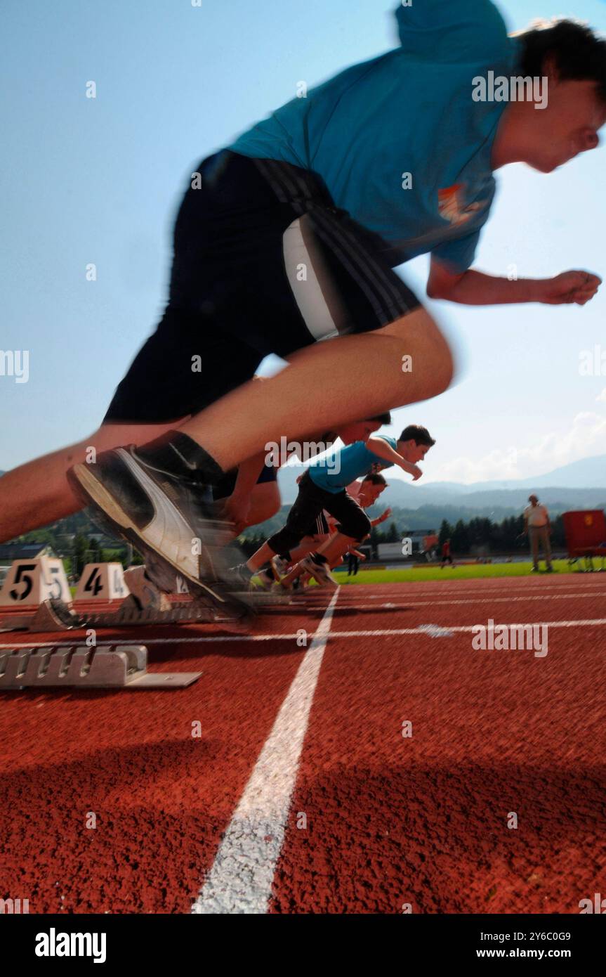 children in start position on the running track, running sport in the ...