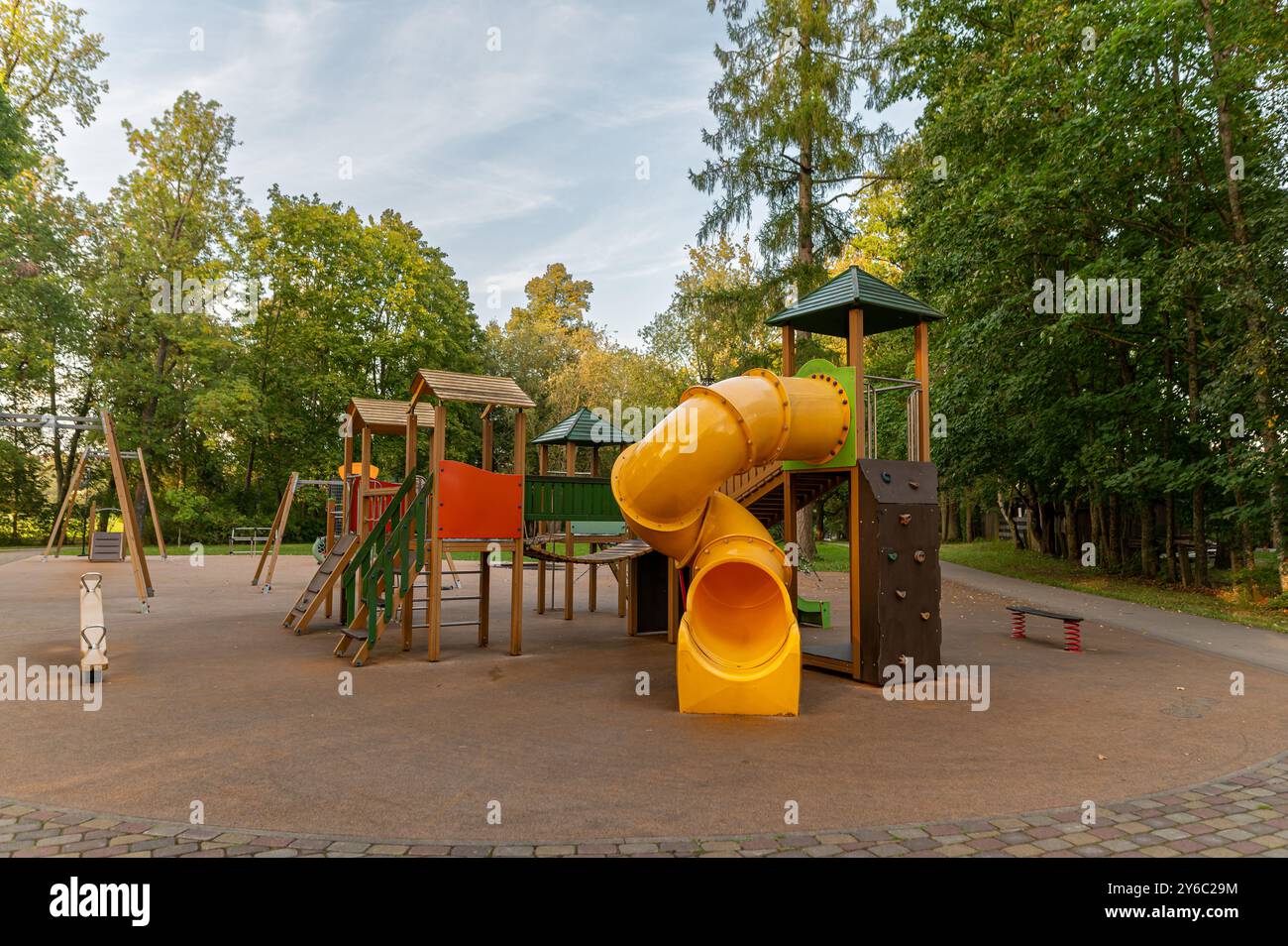 Colorful playground equipment including a slide and climbing features ...