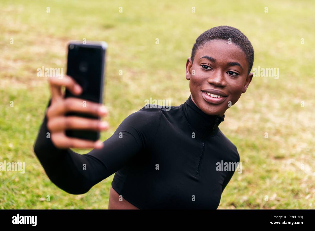ethnic female smiling happy taking self portrait Stock Photo - Alamy