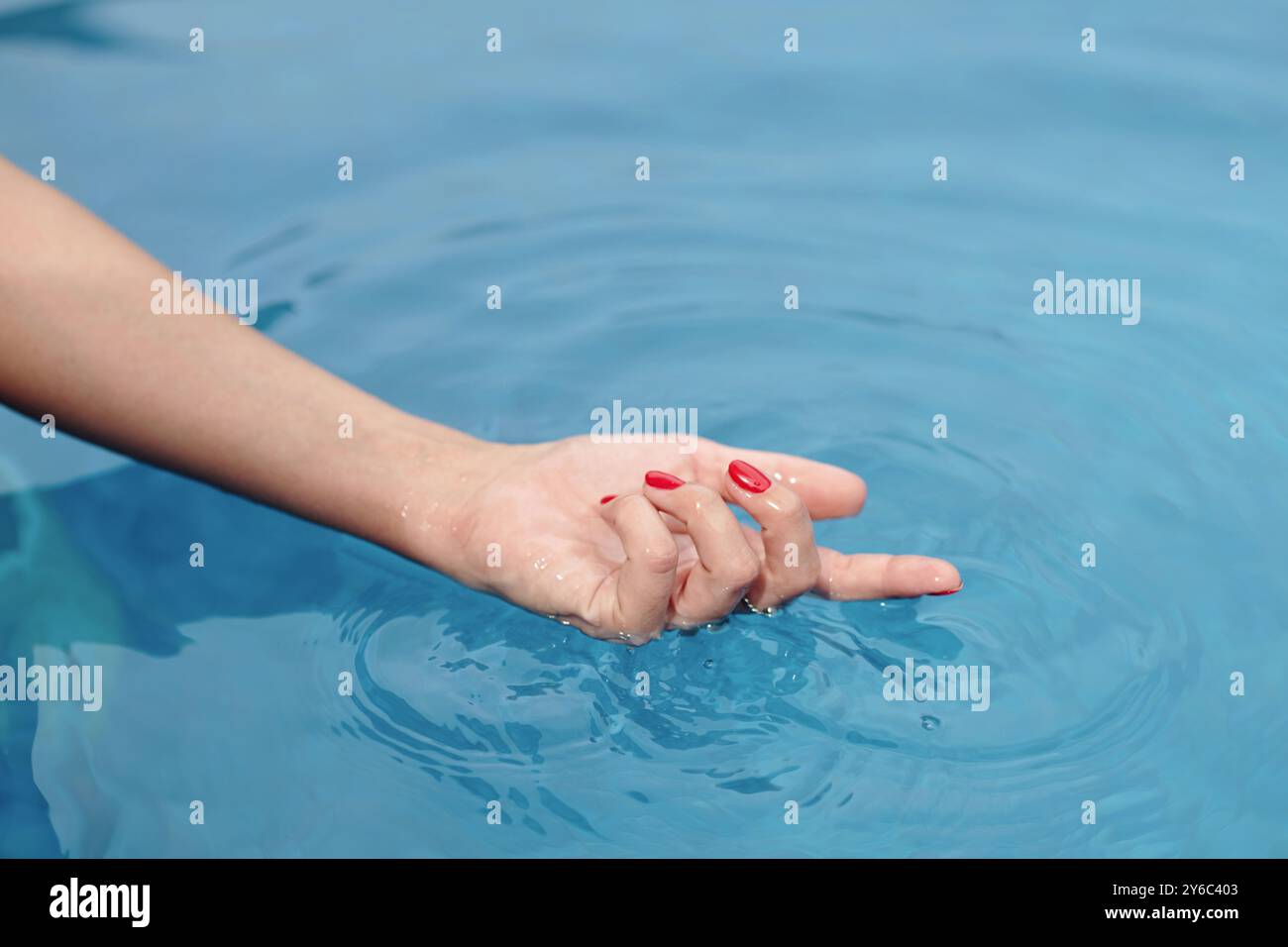 Hand Floating Gently in Blue Water Stock Photo - Alamy