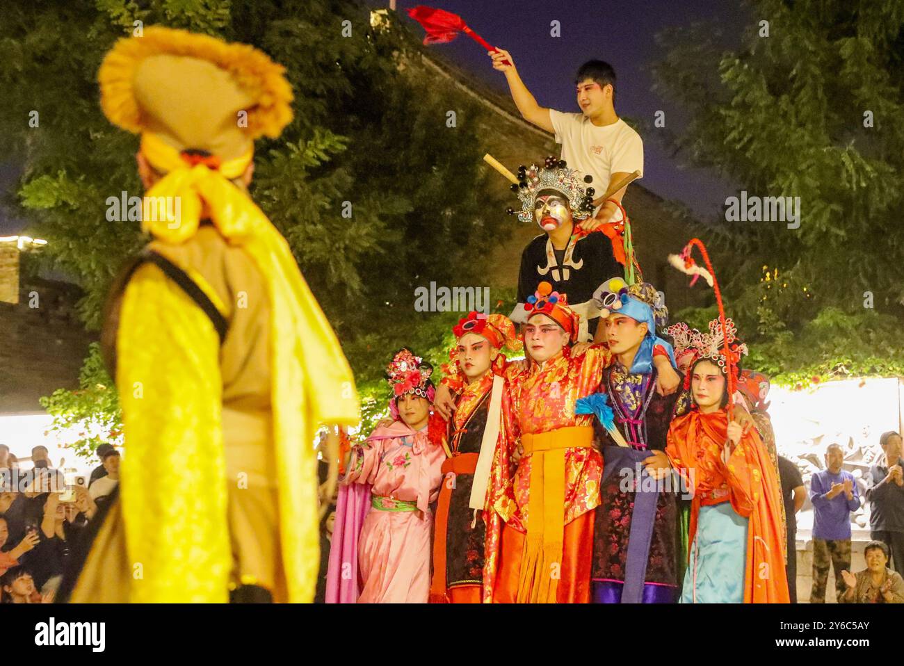 Stilt performers perform for tourists at the ancient town of Xunxian ...