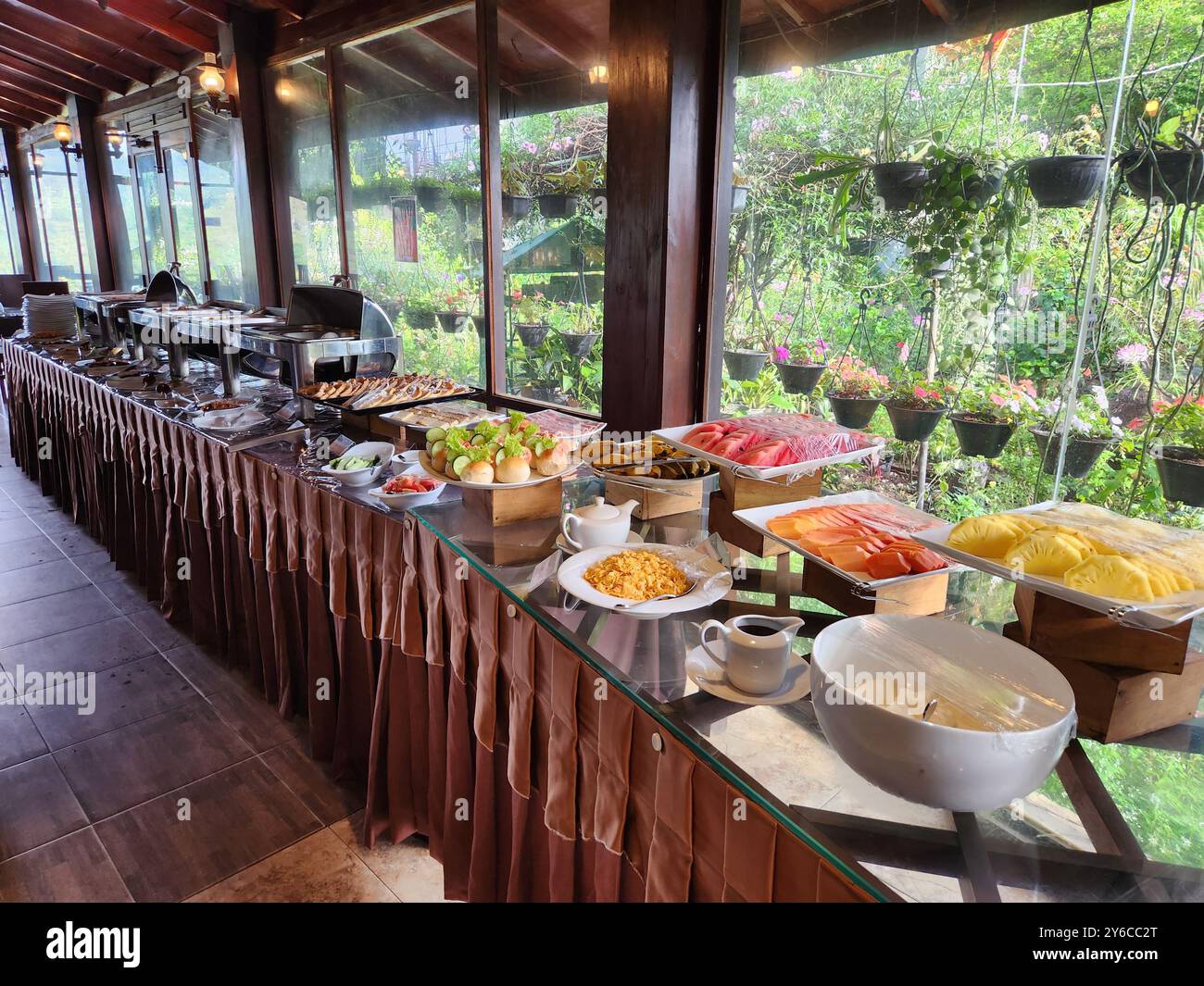 A buffet table with various dishes and fruits in a restaurant with a ...