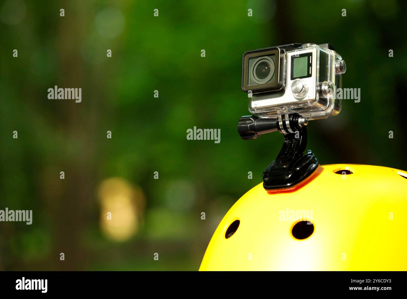Modern action camera with mount on helmet outdoors, closeup. Space for ...