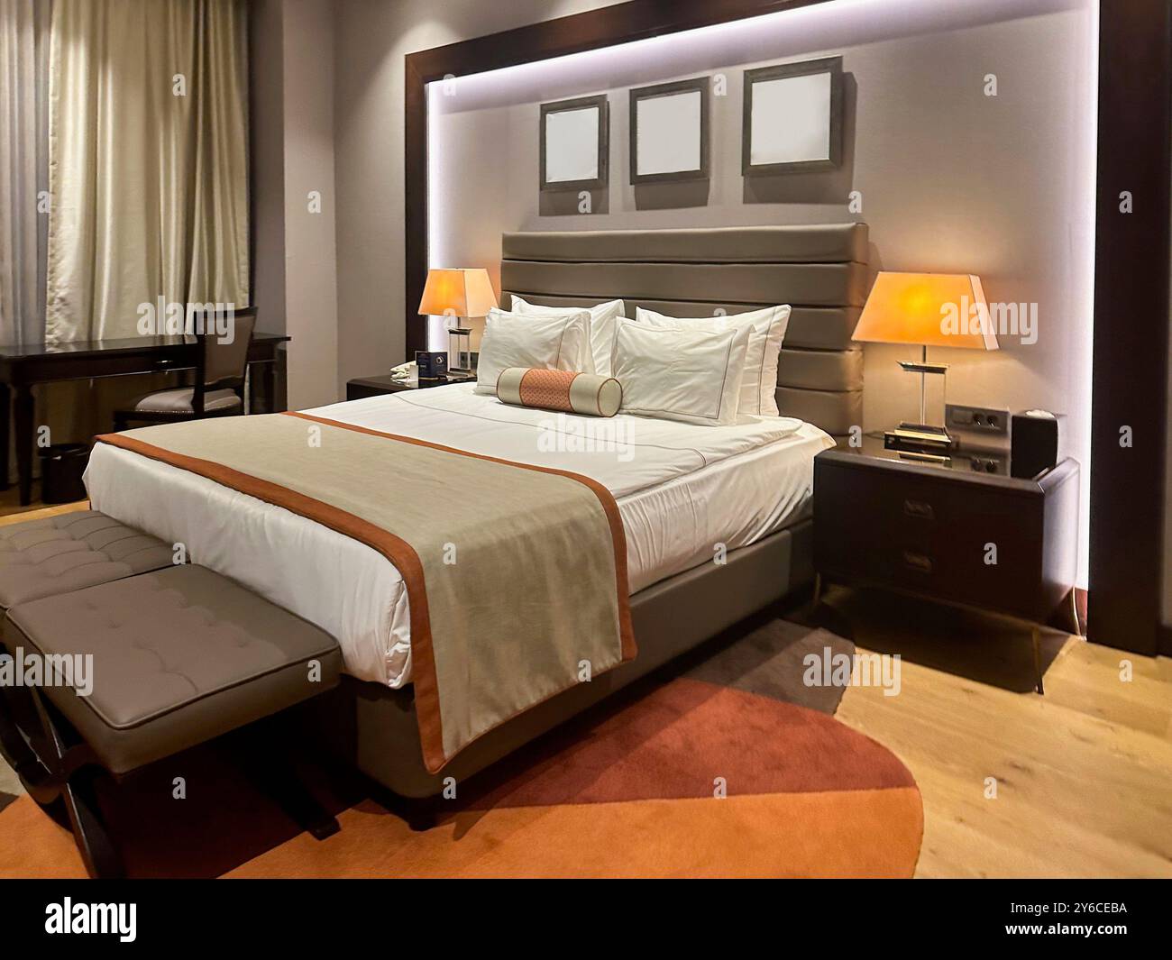 Comfortable large bed in stylish hotel room Stock Photo - Alamy