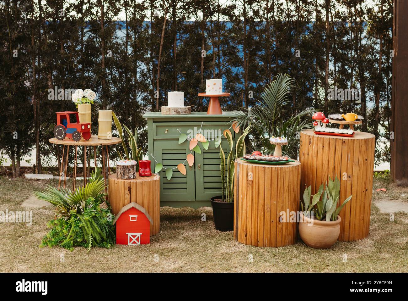 A rustic outdoor setup with wooden tables, plants, and decorative items ...
