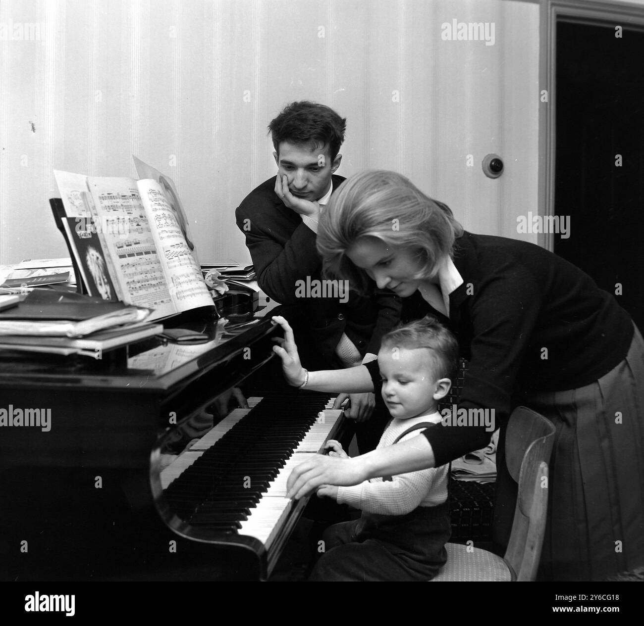 16 DECEMBER 1963 VLADIMIR ASHKENAZY, THE FAMOUS RUSSIAN PIANIST, WATCHING HIS WIFE TEACH HIS SON ...