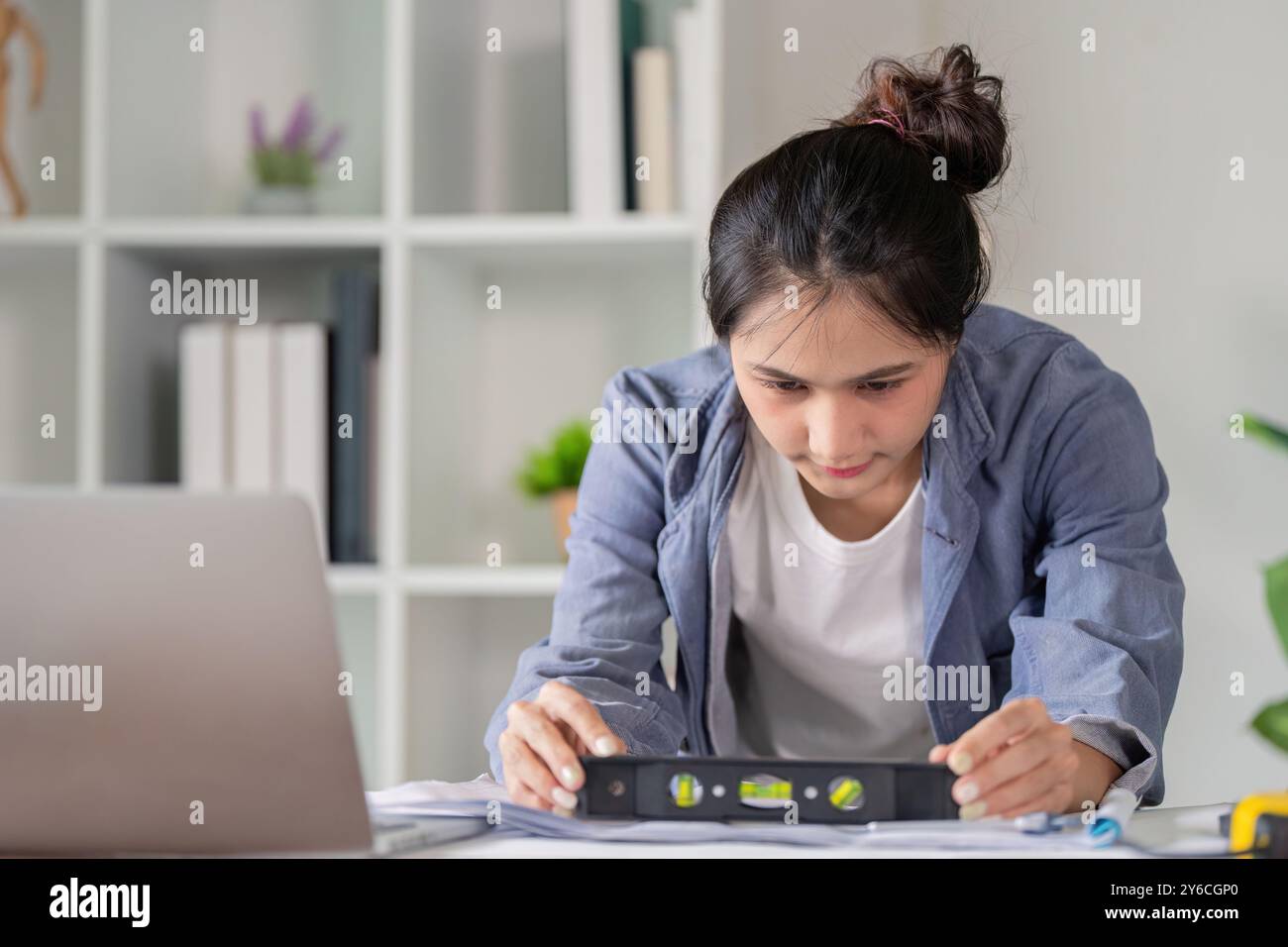 Diligent Female Engineer Using Level Tool to Review Project Details in ...