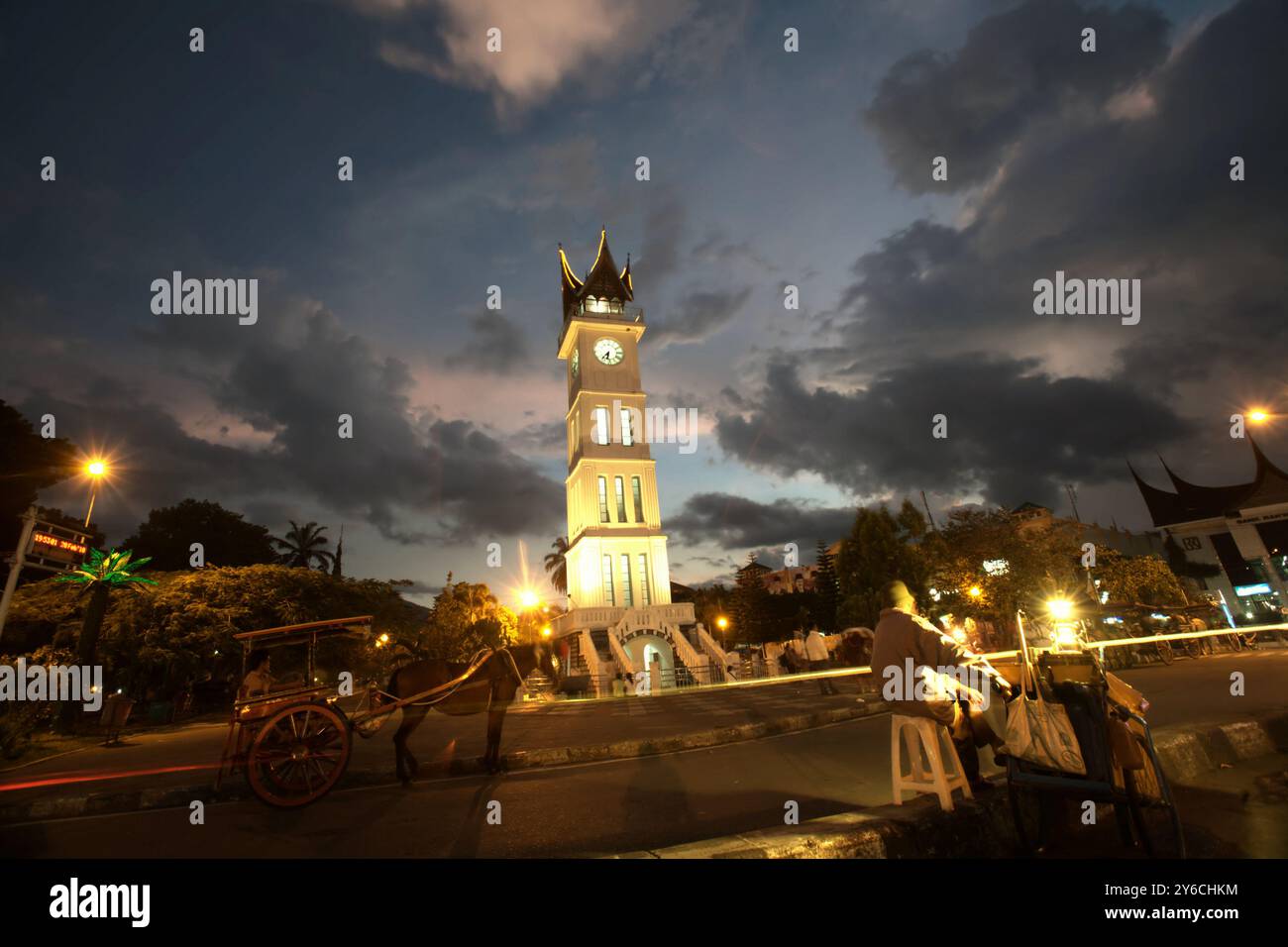 Steamed peanuts vendor and horse-drawn carriage in a background of big ...