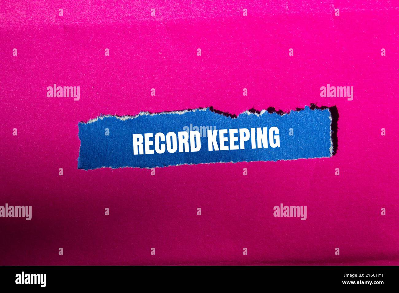 Record keeping message written on ripped torn blue paper piece with pink background. Conceptual ...