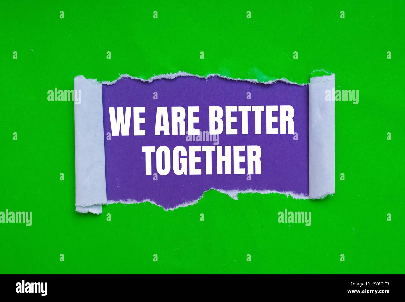 We are better together message written on ripped torn green paper on ...