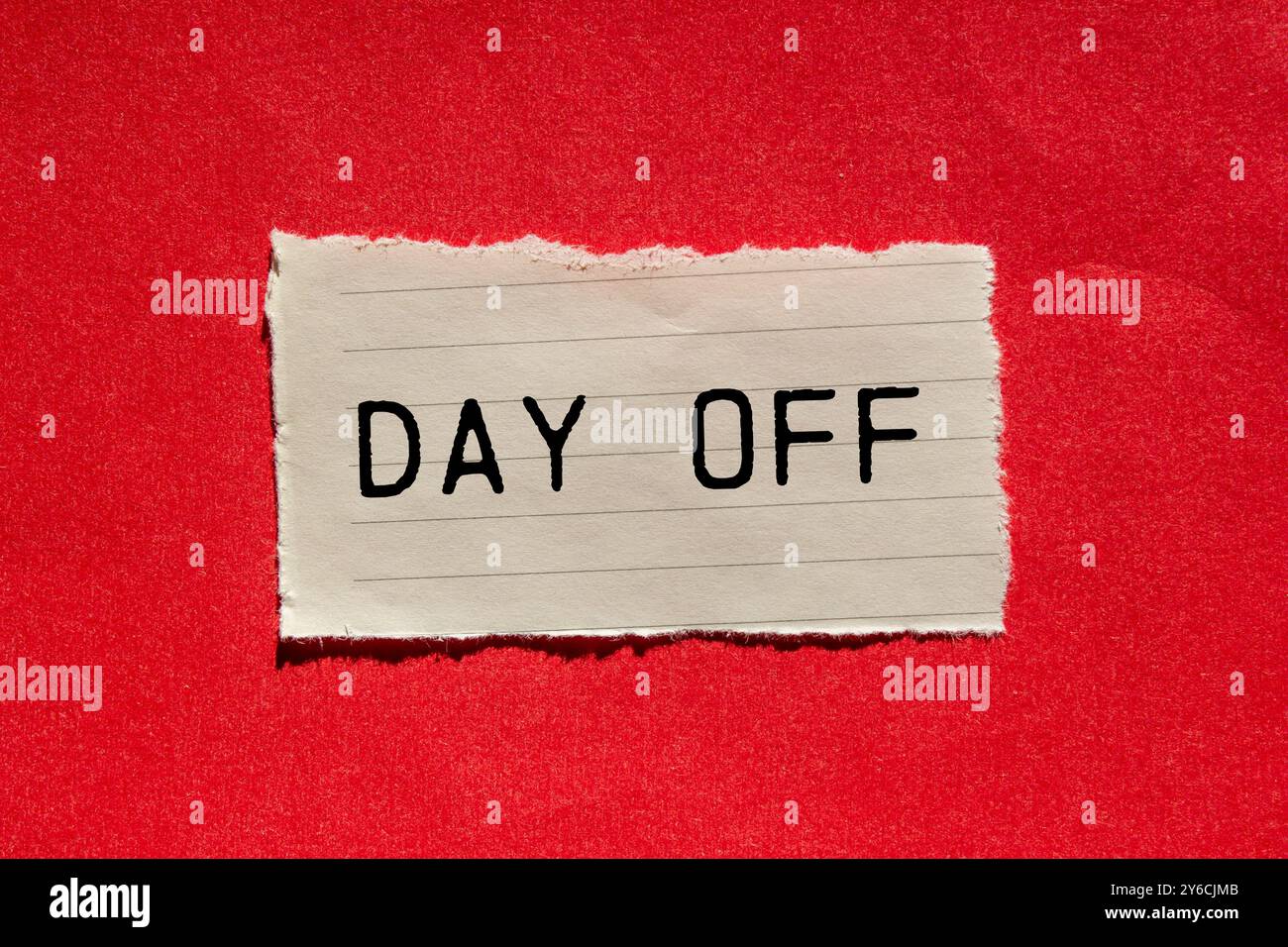 Day off message written on ripped torn paper piece on red background ...