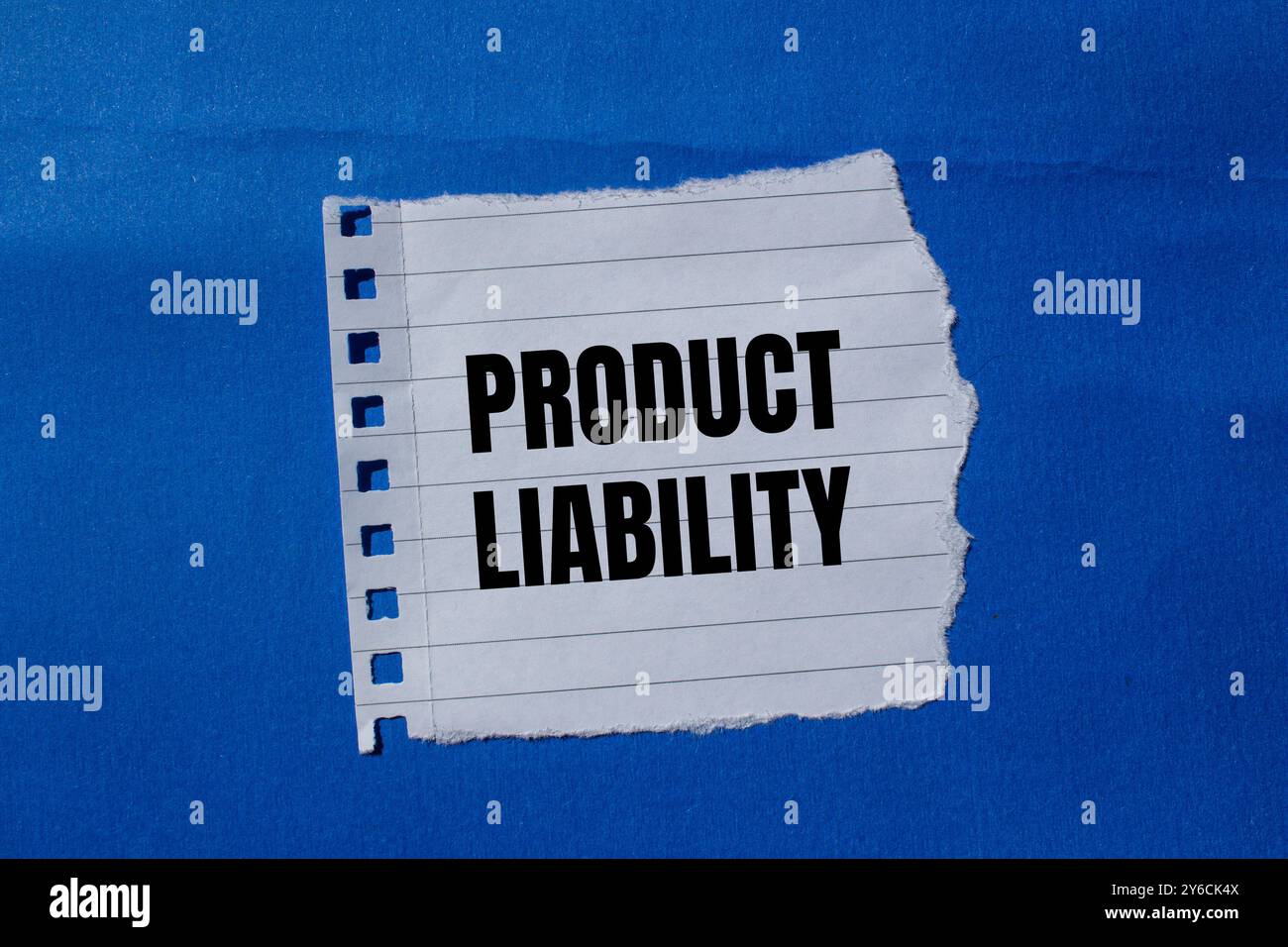 Product liability message written on ripped torn paper piece with blue ...