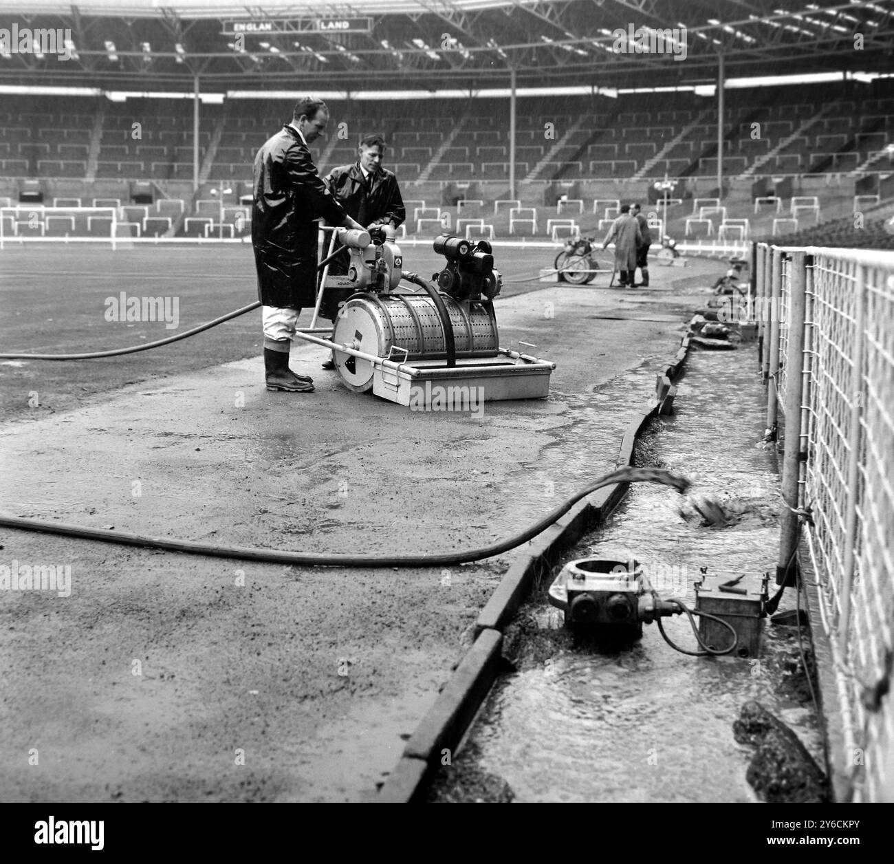STADIUMS WORKERS DRAWING WATER OFF PITCH AQUADRI WATER COLLECTION AT ...
