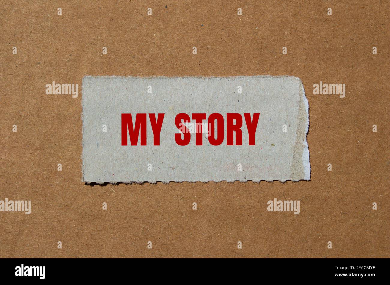 My story message written on ripped torn paper piece with cardboard background. Conceptual my ...