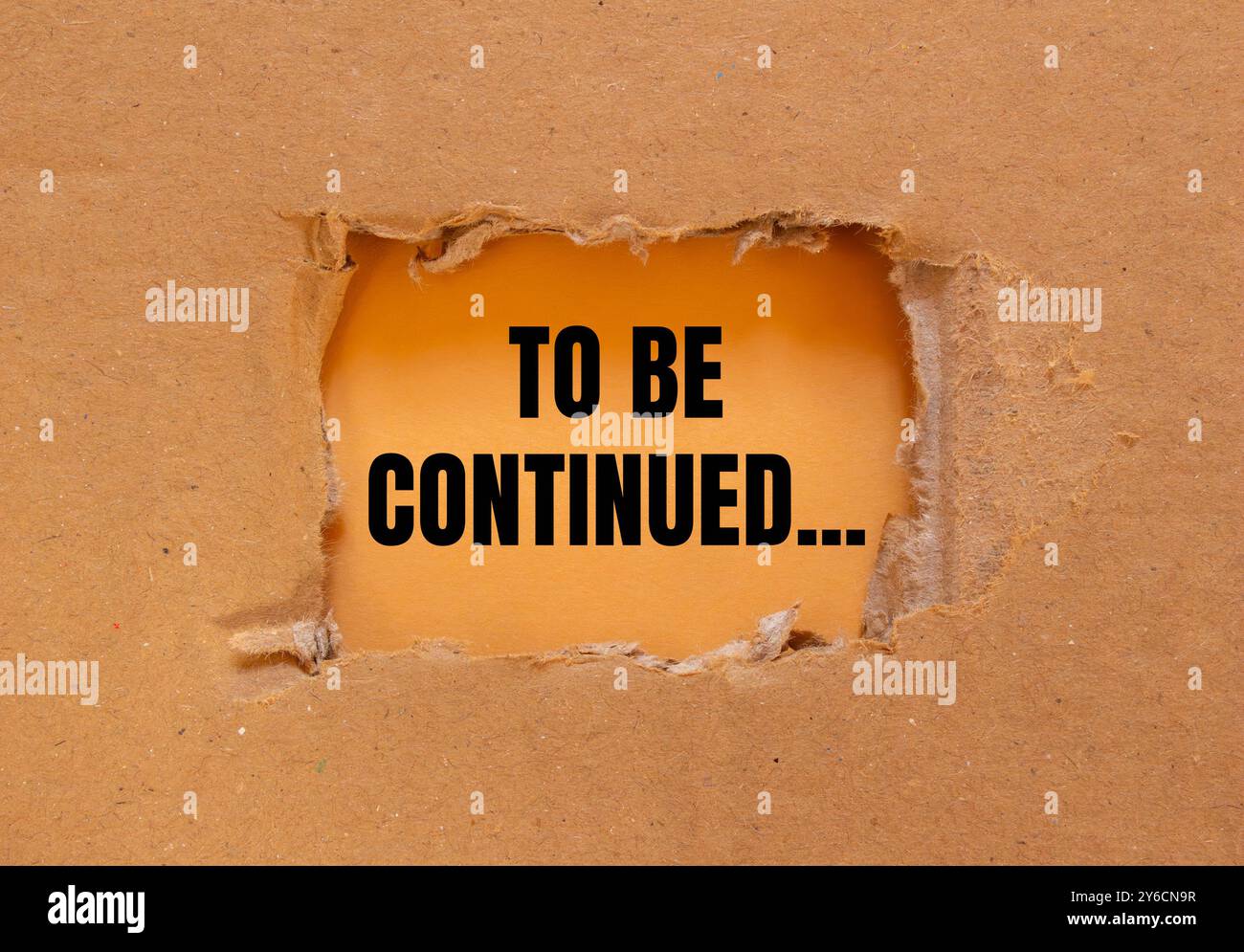 To be continued message written on ripped torn cardboard paper with ...