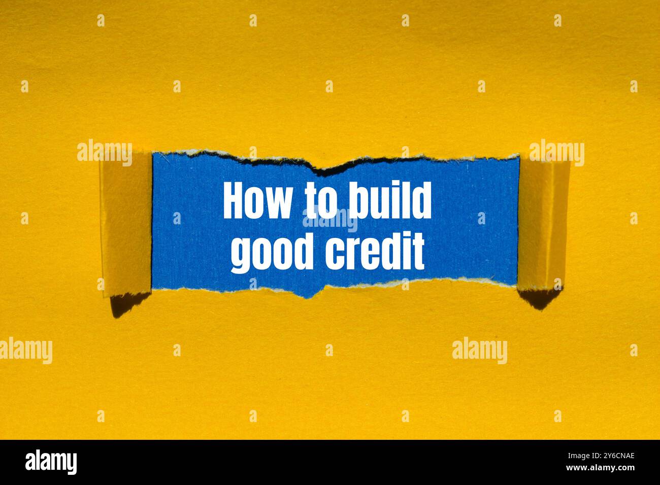 How to build good credit message written on ripped torn yellow paper ...