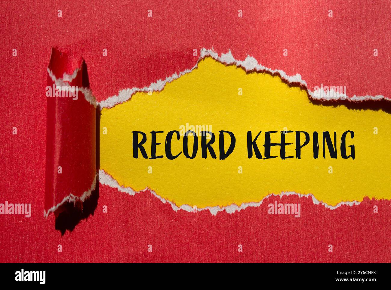 Record keeping message written on ripped torn red paper with yellow background. Conceptual ...