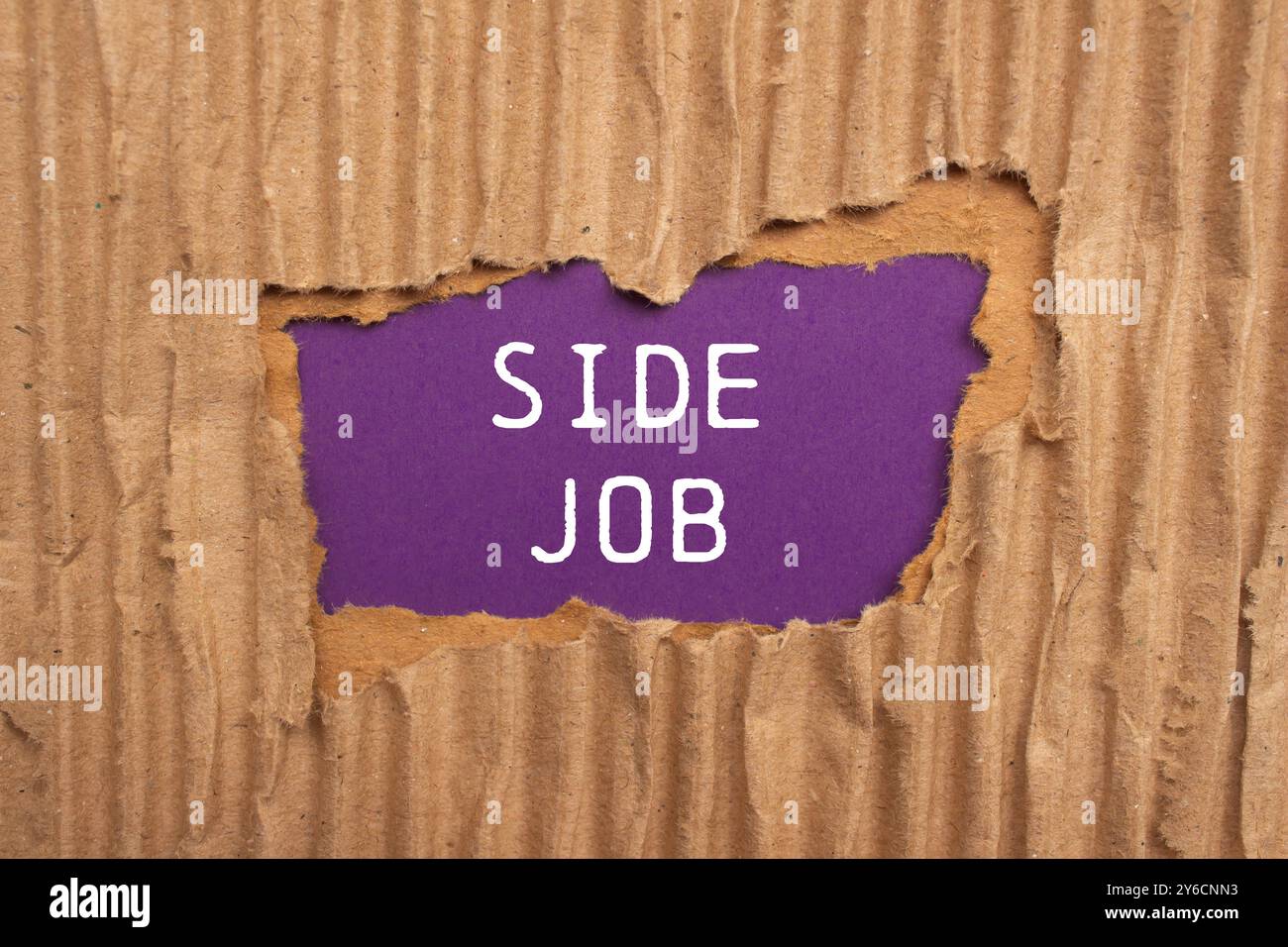 Side job message written on ripped torn cardboard paper on purple background. Conceptual side ...