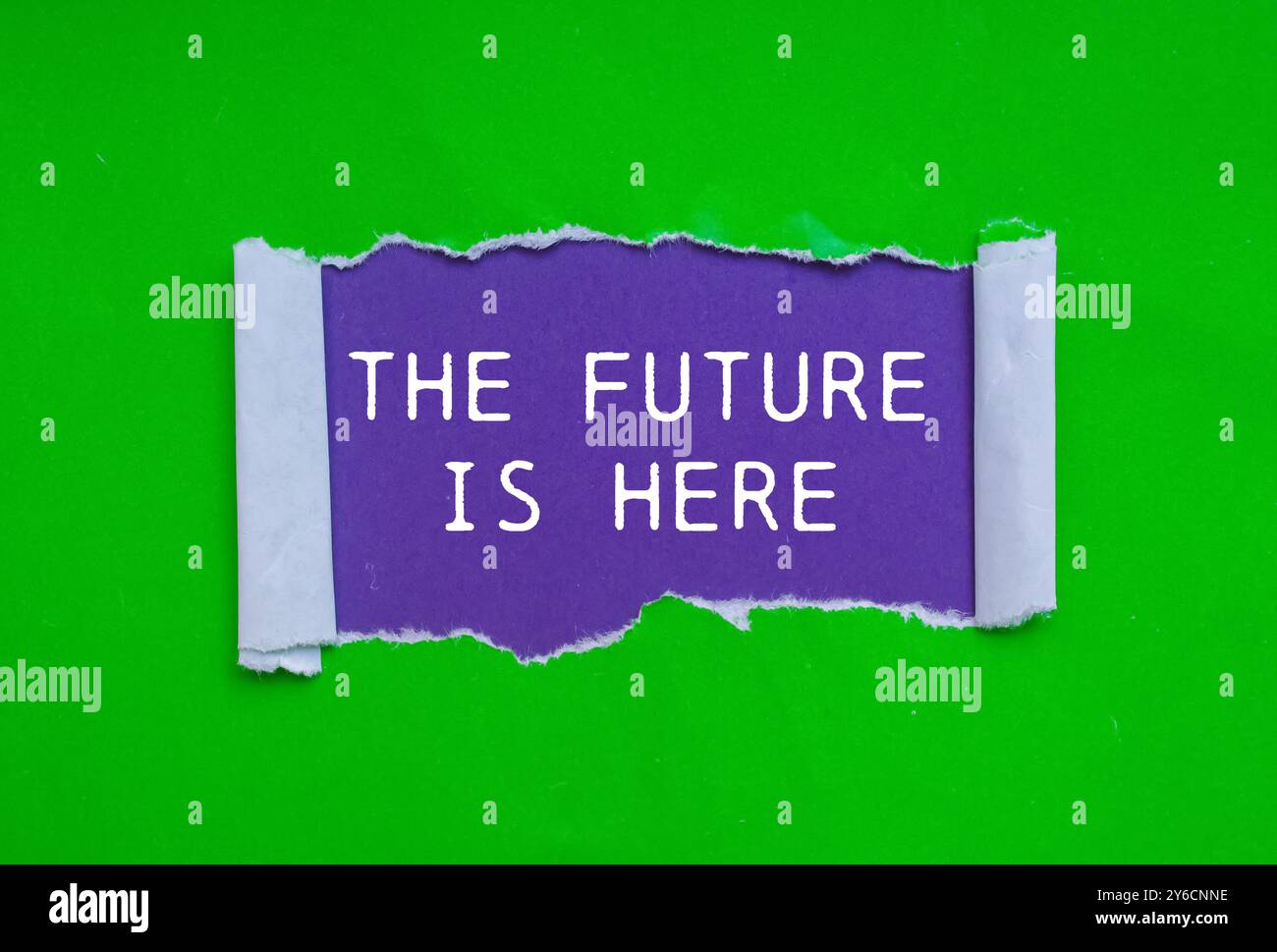 The future is here message written on ripped torn green paper on purple ...