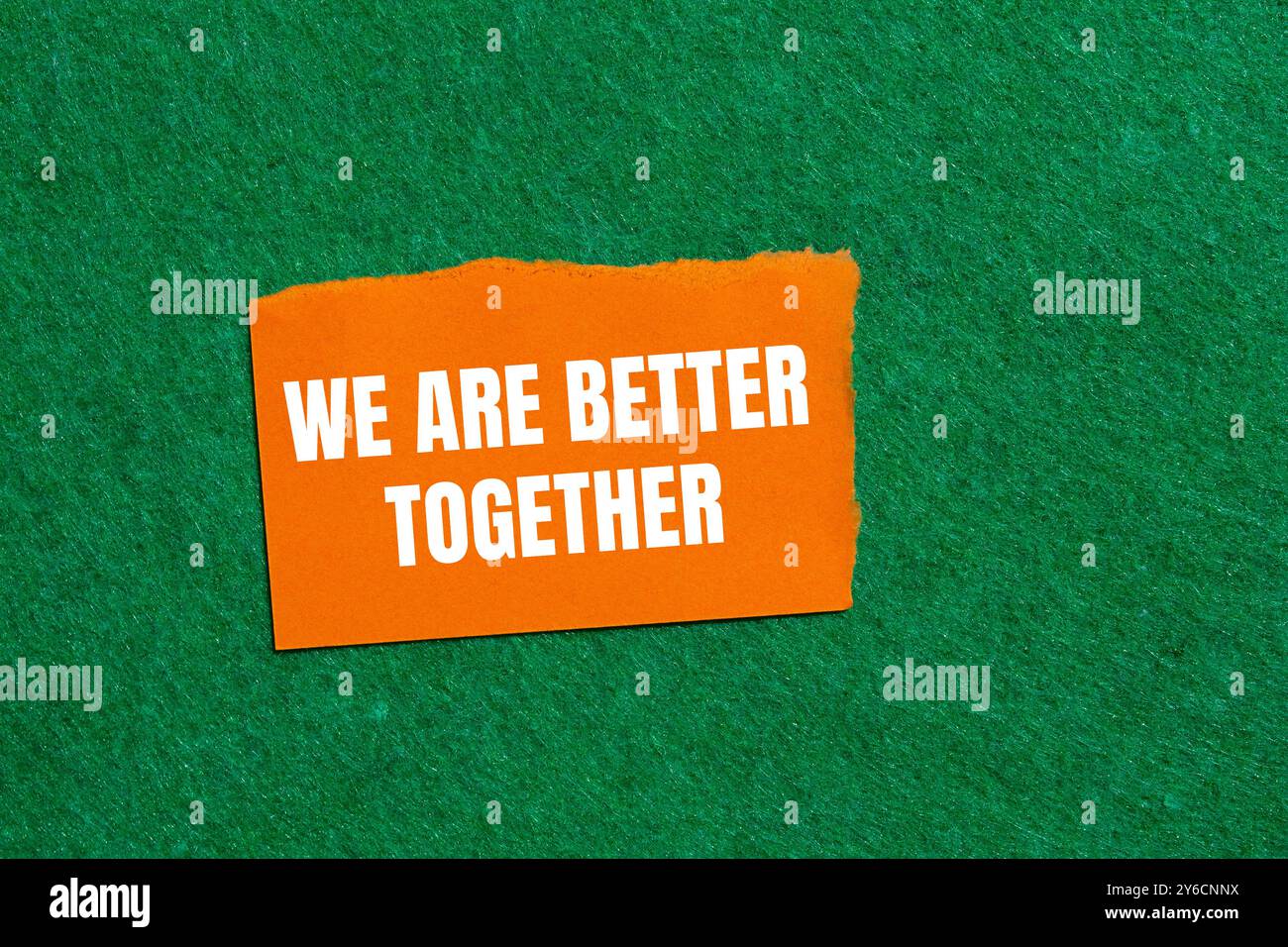 We are better together message written on ripped orange torn paper ...