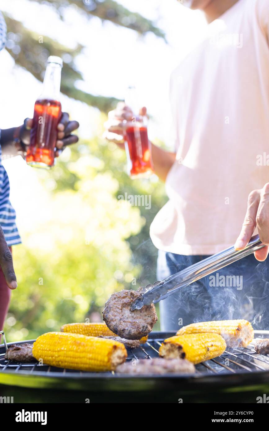 Grilling barbecue outdoors diverse people hi-res stock photography and ...