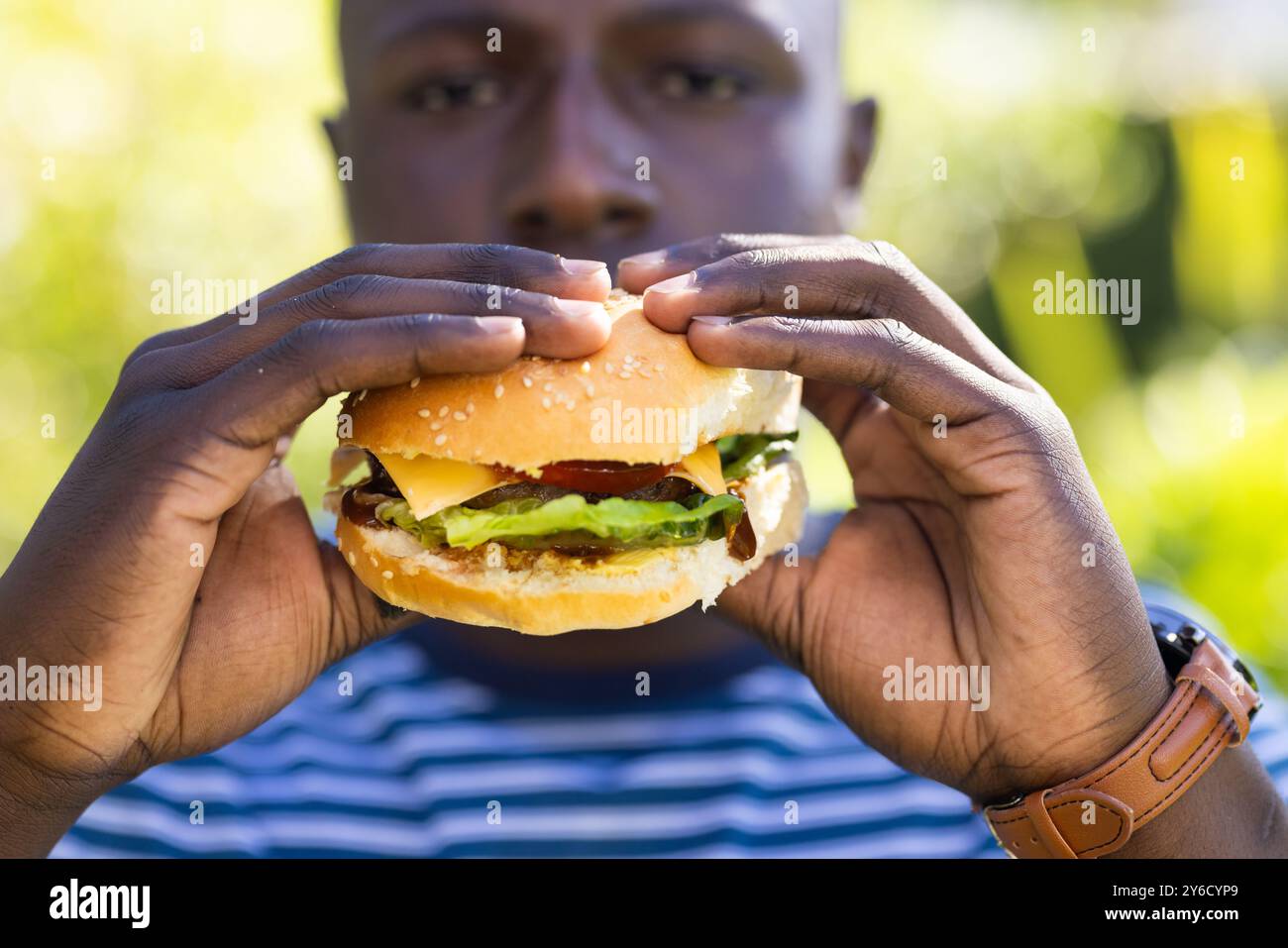 Close-up, Holding burger, african american man preparing to take bite ...