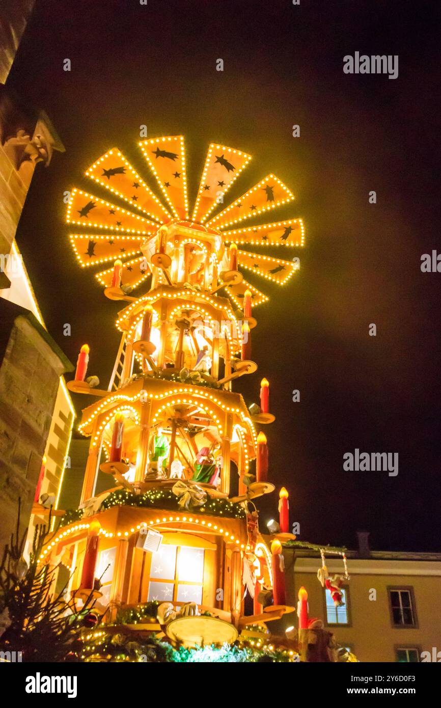 Traditional spinning Christmas pyramid lit up at night, at Christmas ...