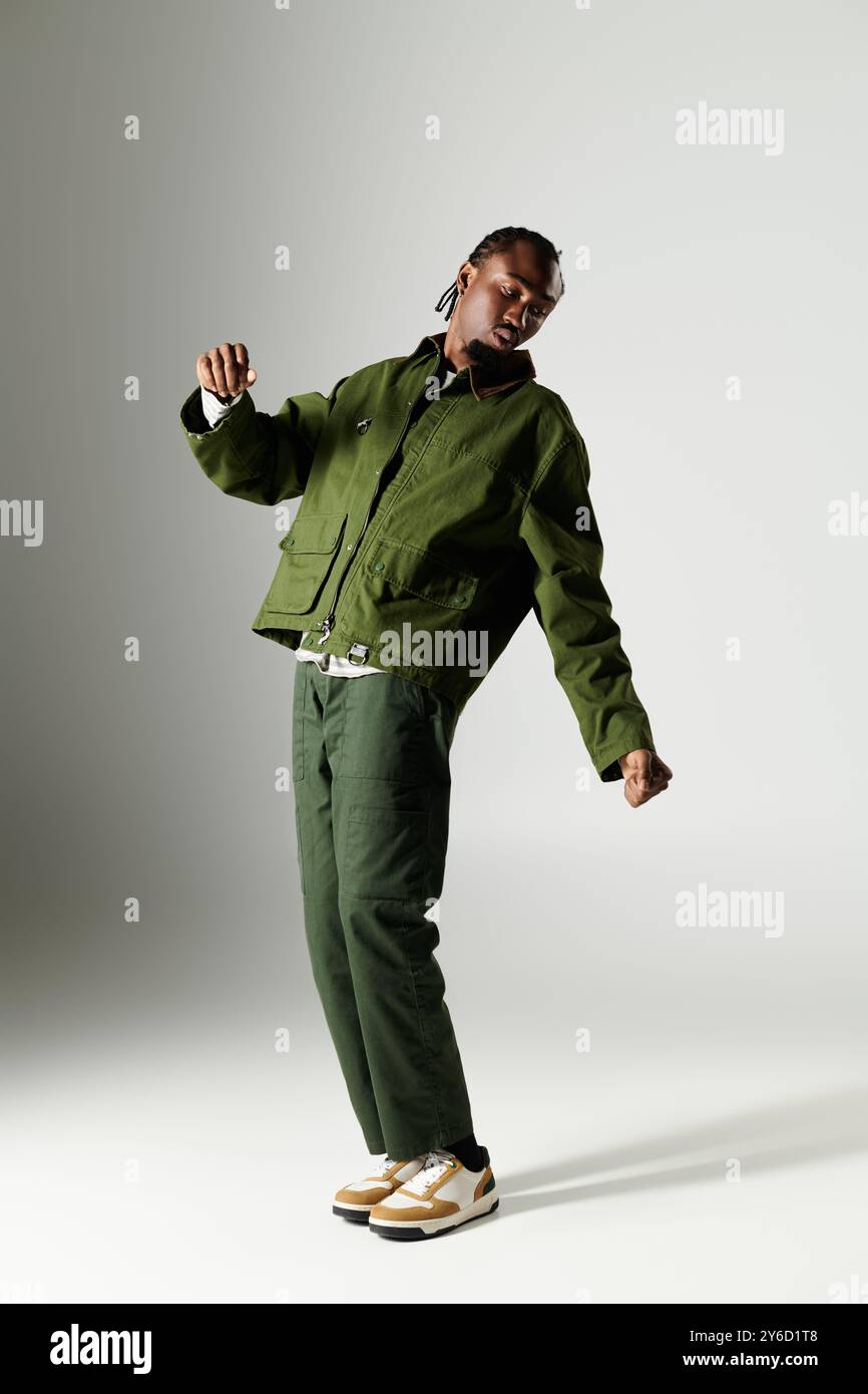 A young man showcases confidence and style in green clothing while ...