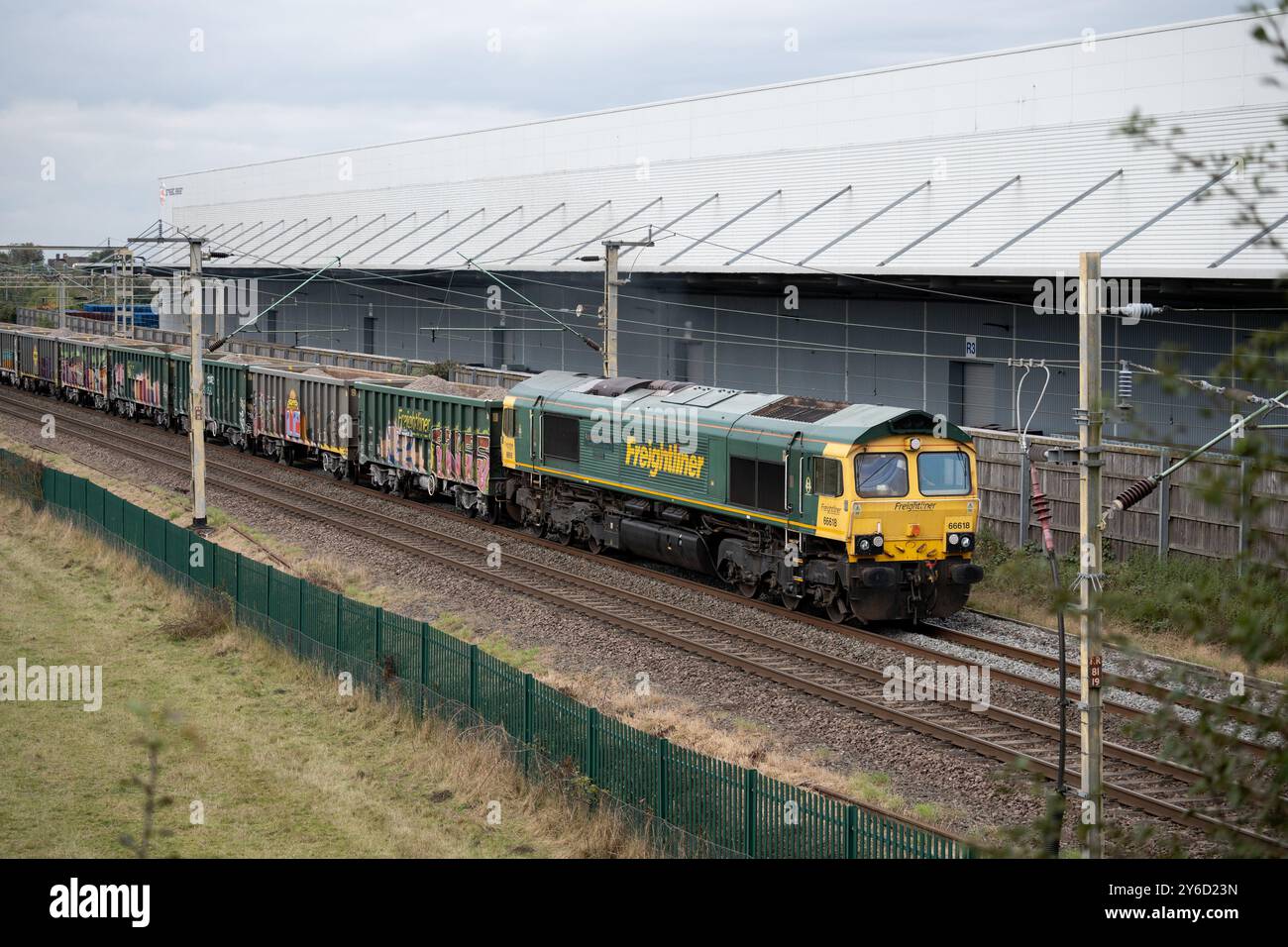 Freightliner class 66 diesel locomotive No. 66618 "Railways Illustrated" pulling a stone train ...