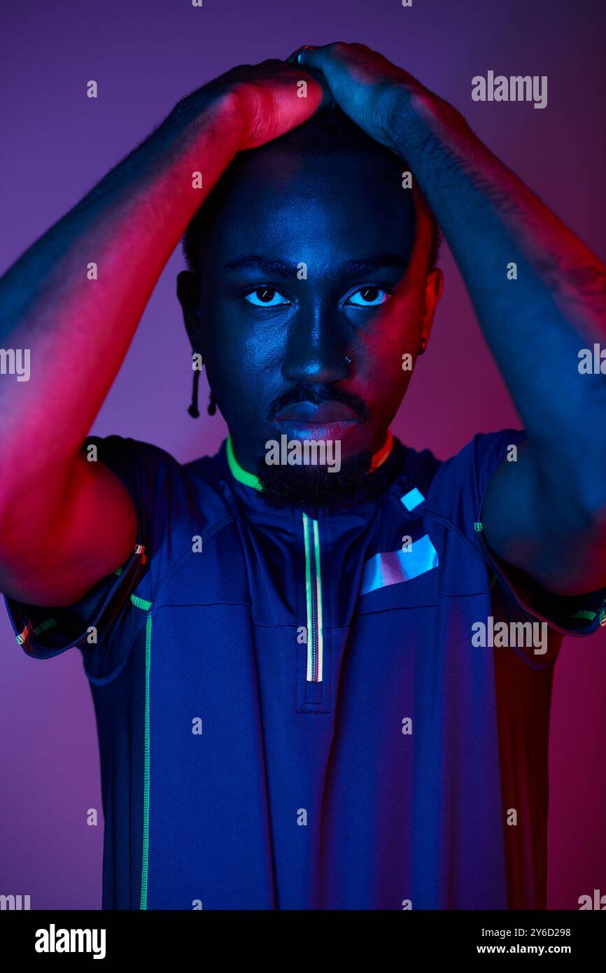 A young African American man in trendy attire expresses himself under ...