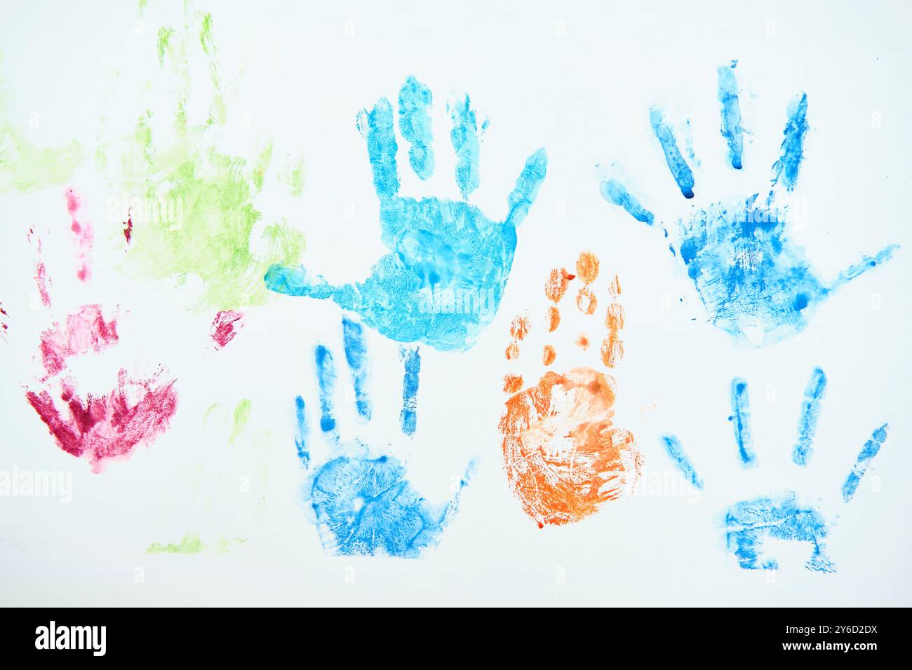 Bright children's handprints made with blue, green, red and orange ...