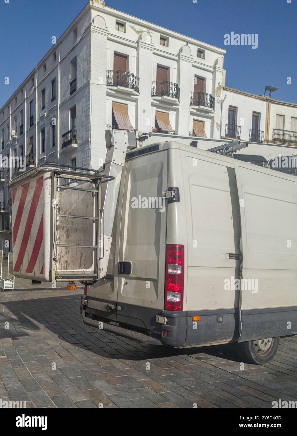 Large commercial van equipped with telescopic boom basket. View from ...