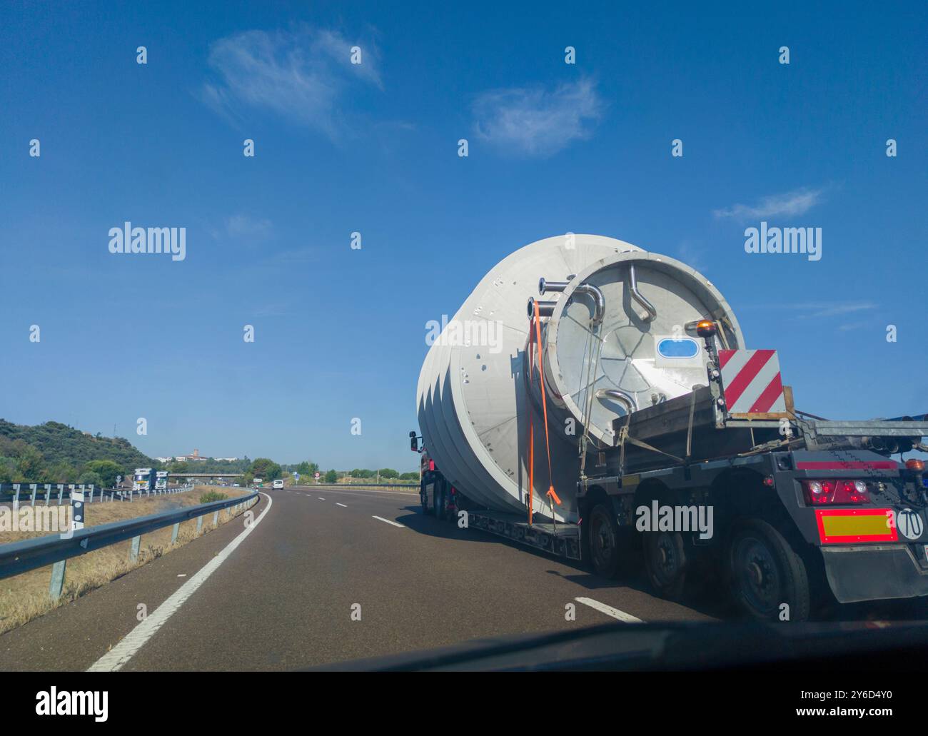Driving behind oversize load truck. View from the inside of the car ...
