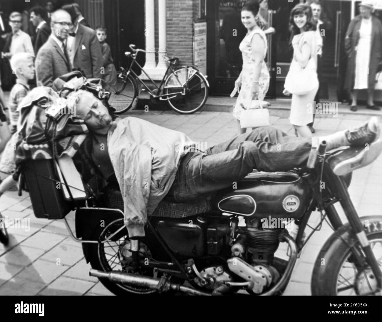 VIEW OF A MAN SLEEPING ON MOTOR BIKE IN AMSTERDAM ; 3 AUGUST 1963 Stock Photo - Alamy