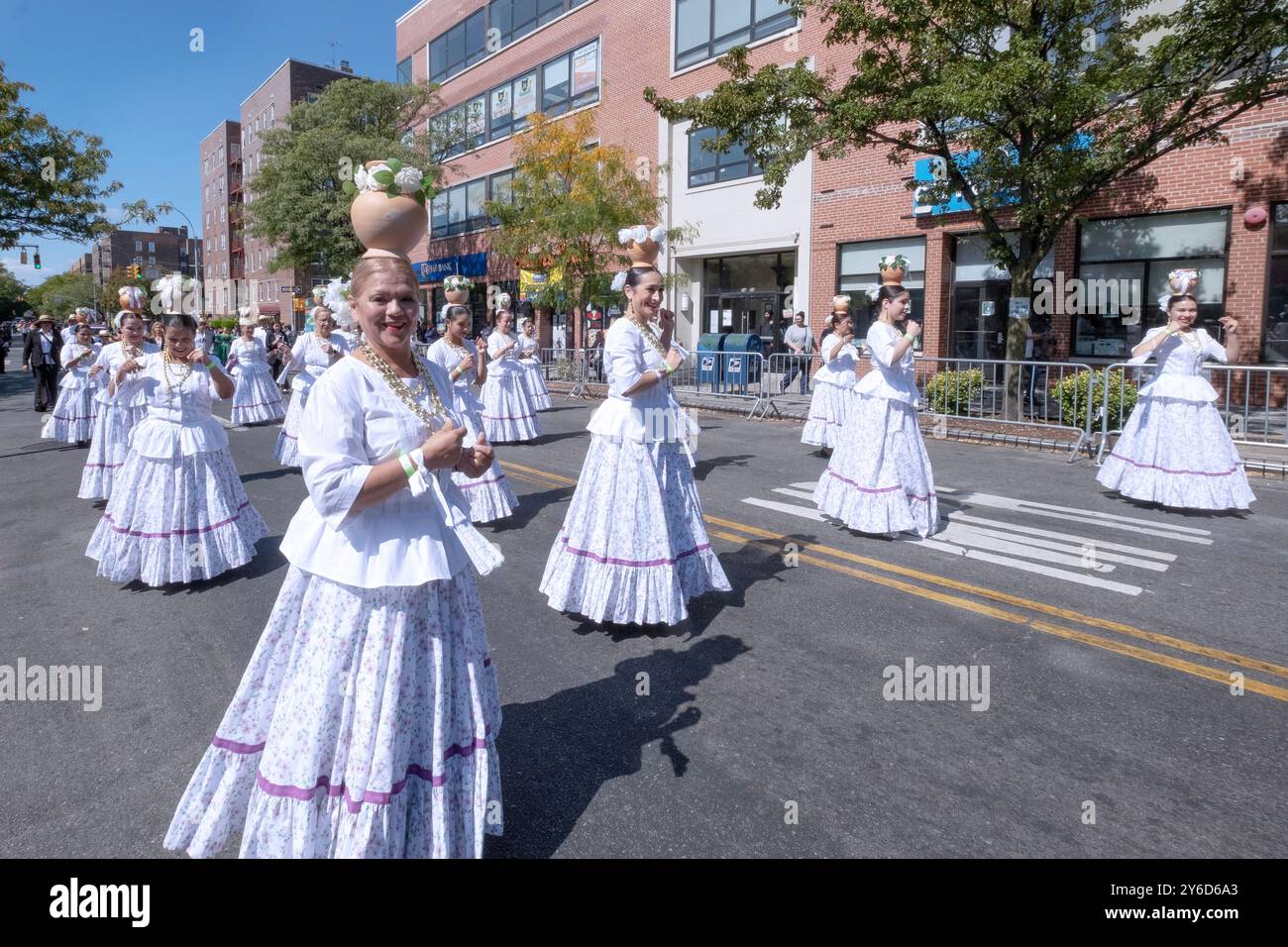 An age diverse group of Paraguayan women dance & march in white ...