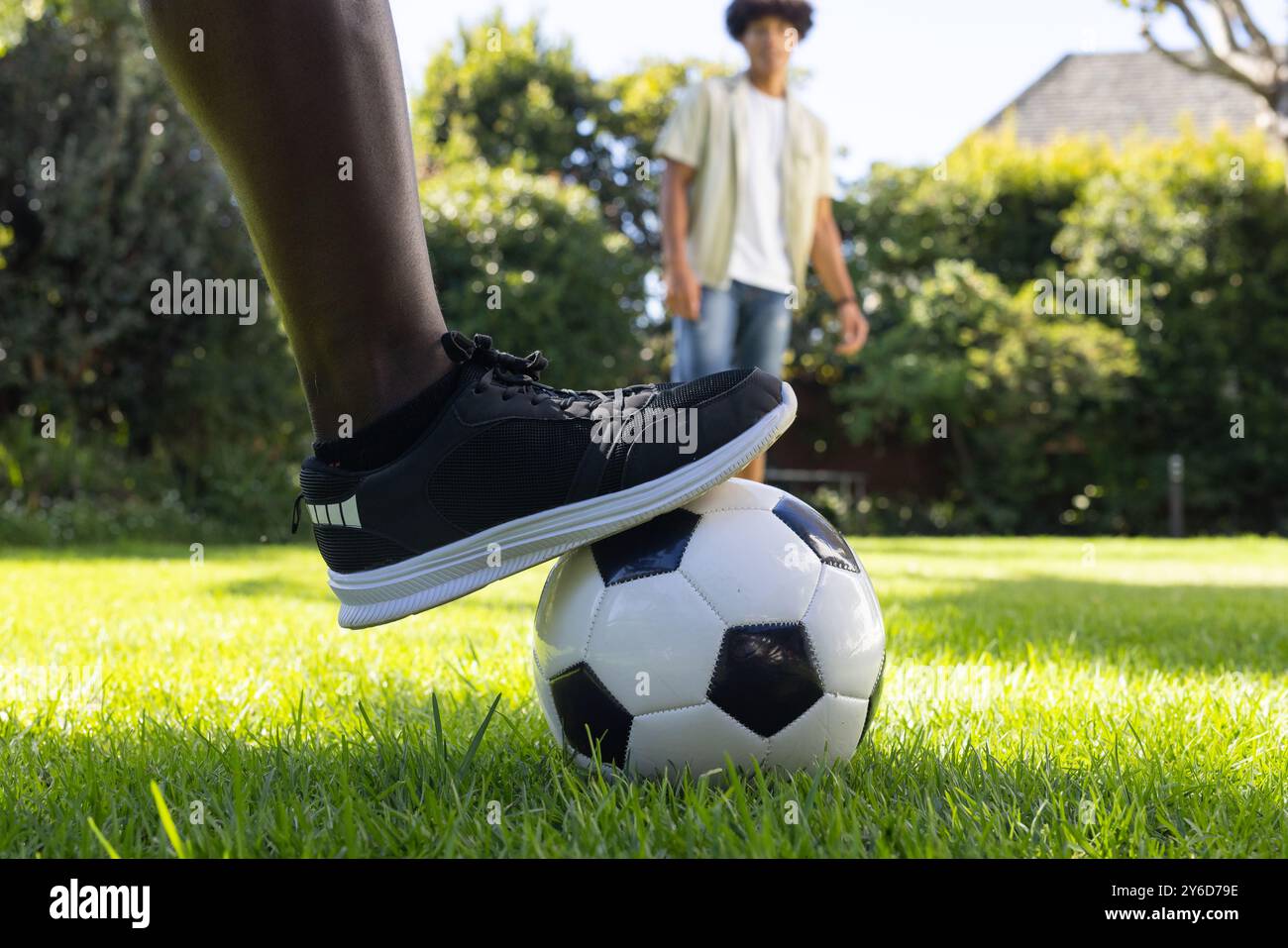 Outdoors, Playing soccer, african american man stepping on ball while ...
