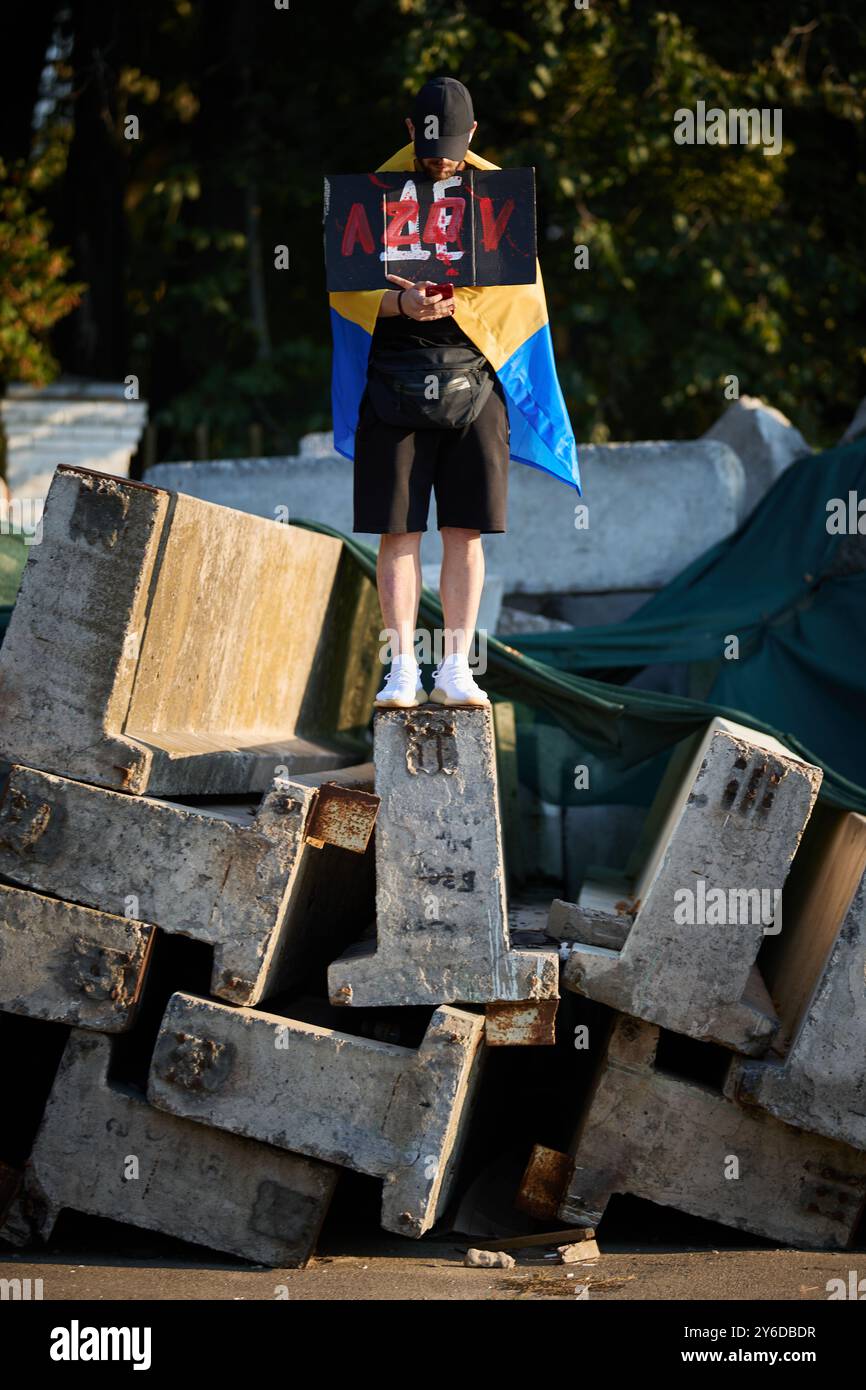 Ukrainian patriot wearing national flag on shoulders demonstrating with ...
