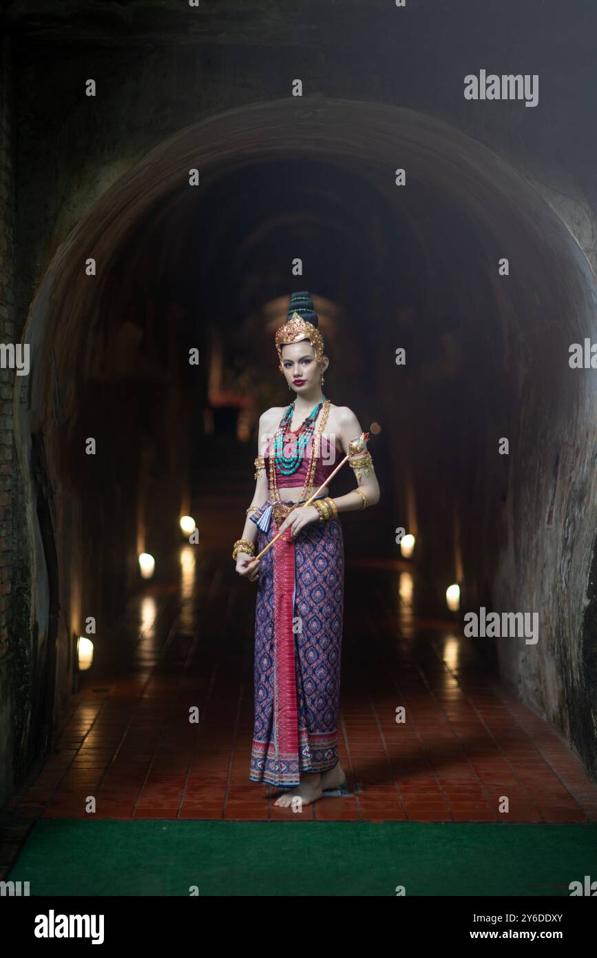 Beautiful young ASEAN woman in traditional Thai Dvaravati dress in an ...