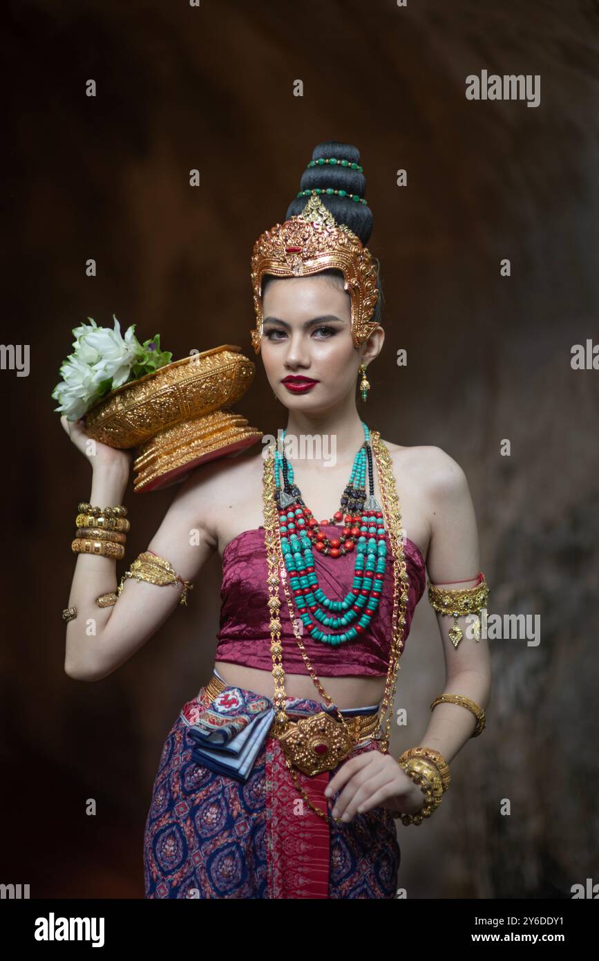 Beautiful young ASEAN woman in traditional Thai Dvaravati dress in an ...