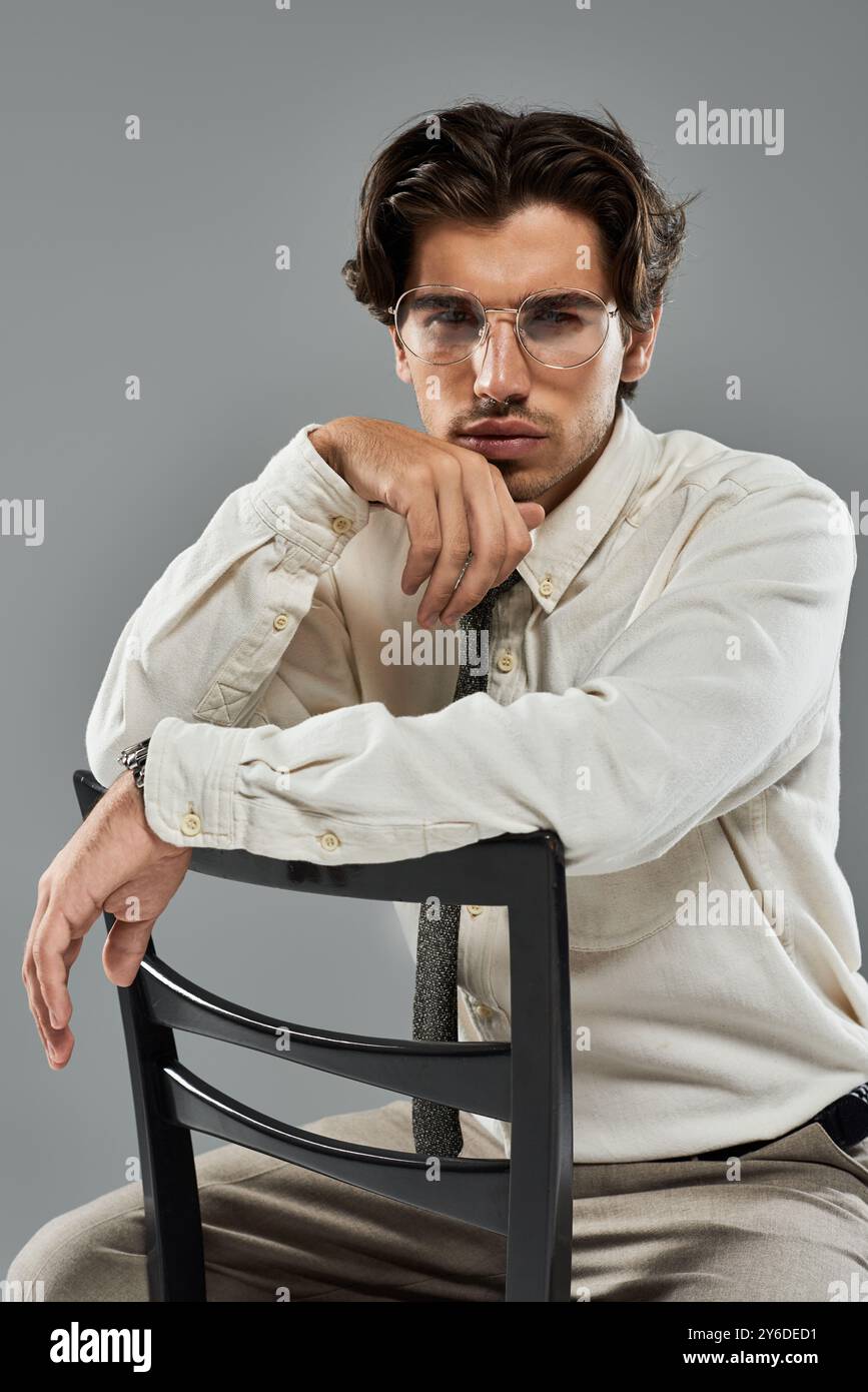 A young man dressed in elegant formal wear confidently poses against a ...