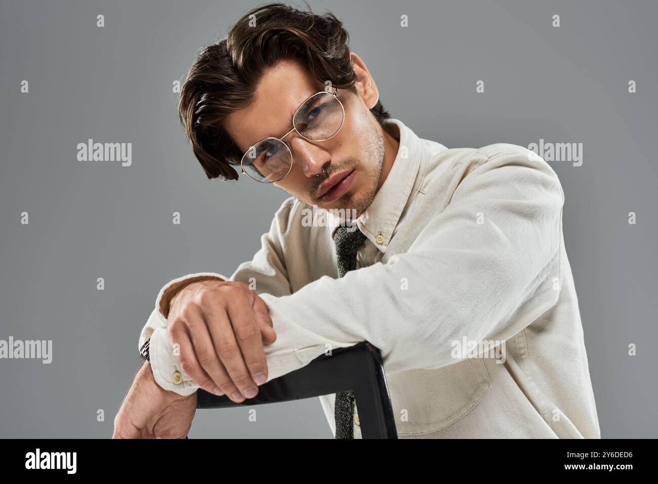 A handsome young man showcases his fashionable formal attire with a ...