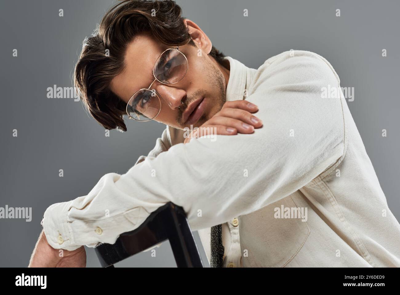 A dapper young man showcases his charm in elegant formal wear while ...