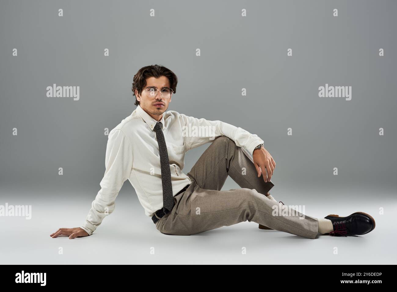 A handsome young man showcases his stylish formal attire while posing ...