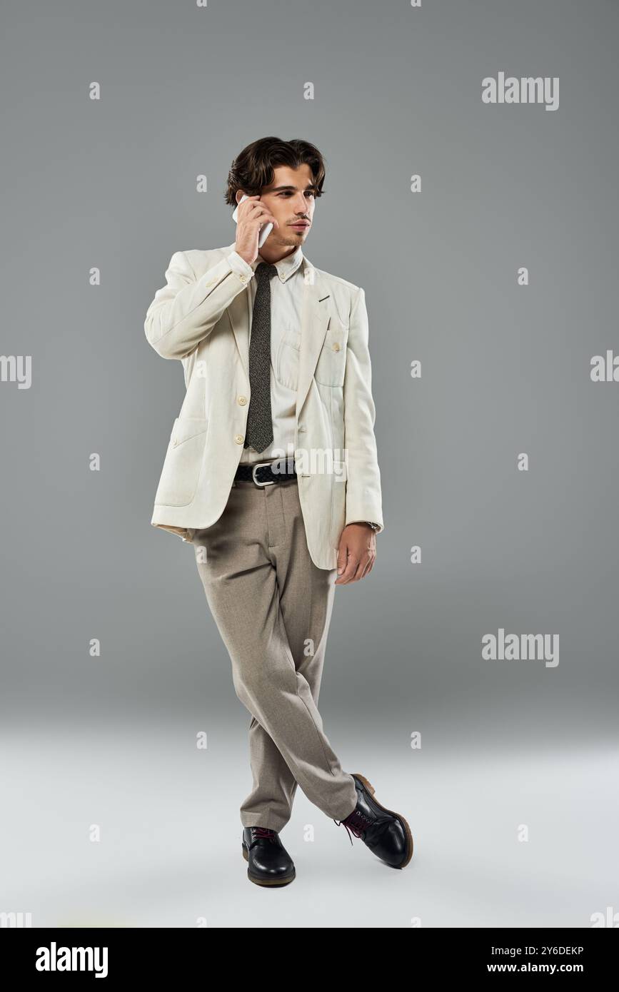 A handsome young man in elegant attire stands poised, showcasing his ...