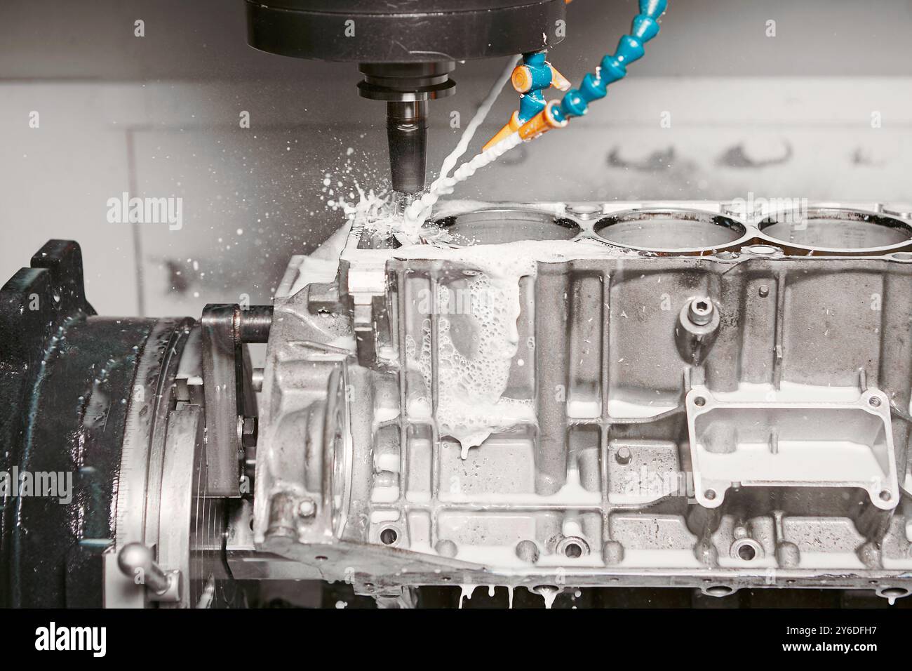 High precision cnc milling machine makes holes in the car engine with a ...