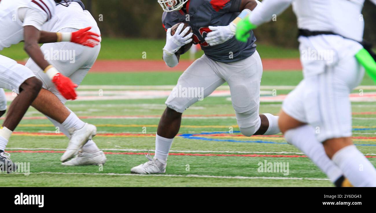 Front view of a high school Football running back running into the ...