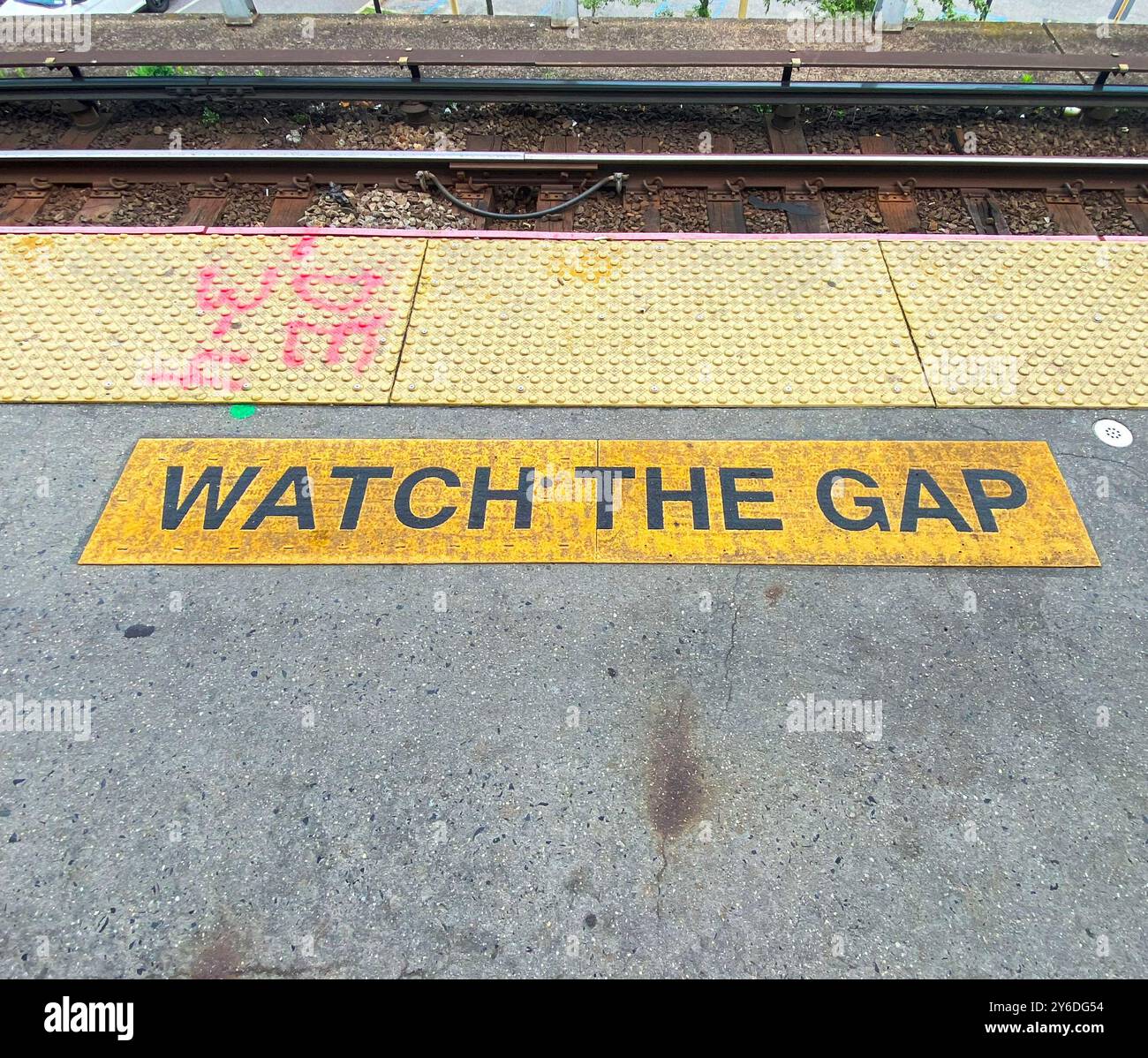Watch the gap printed on a long island railroad train platform Stock Photo - Alamy