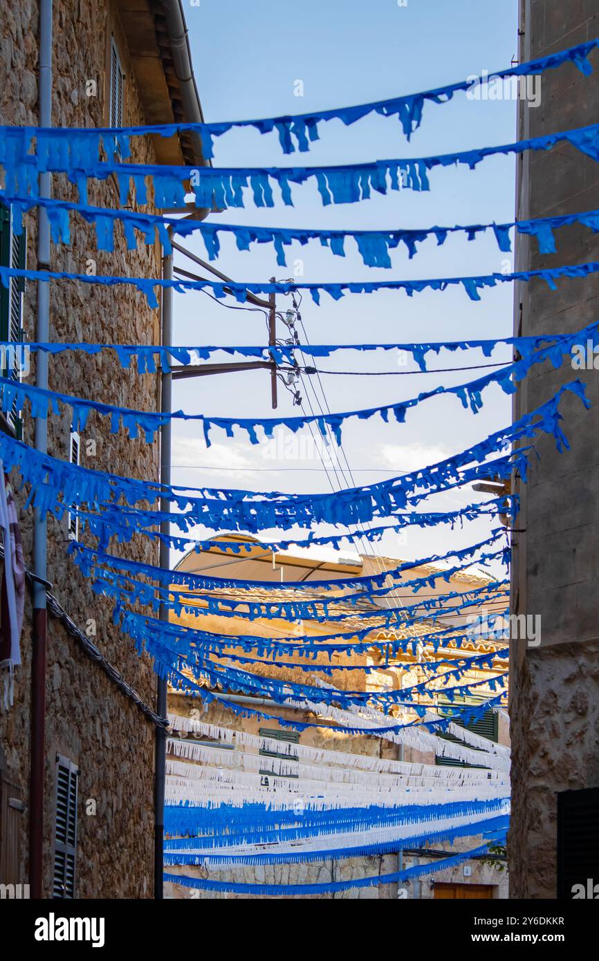 Blue and white flags hanging in the streets of a small town expressing ...